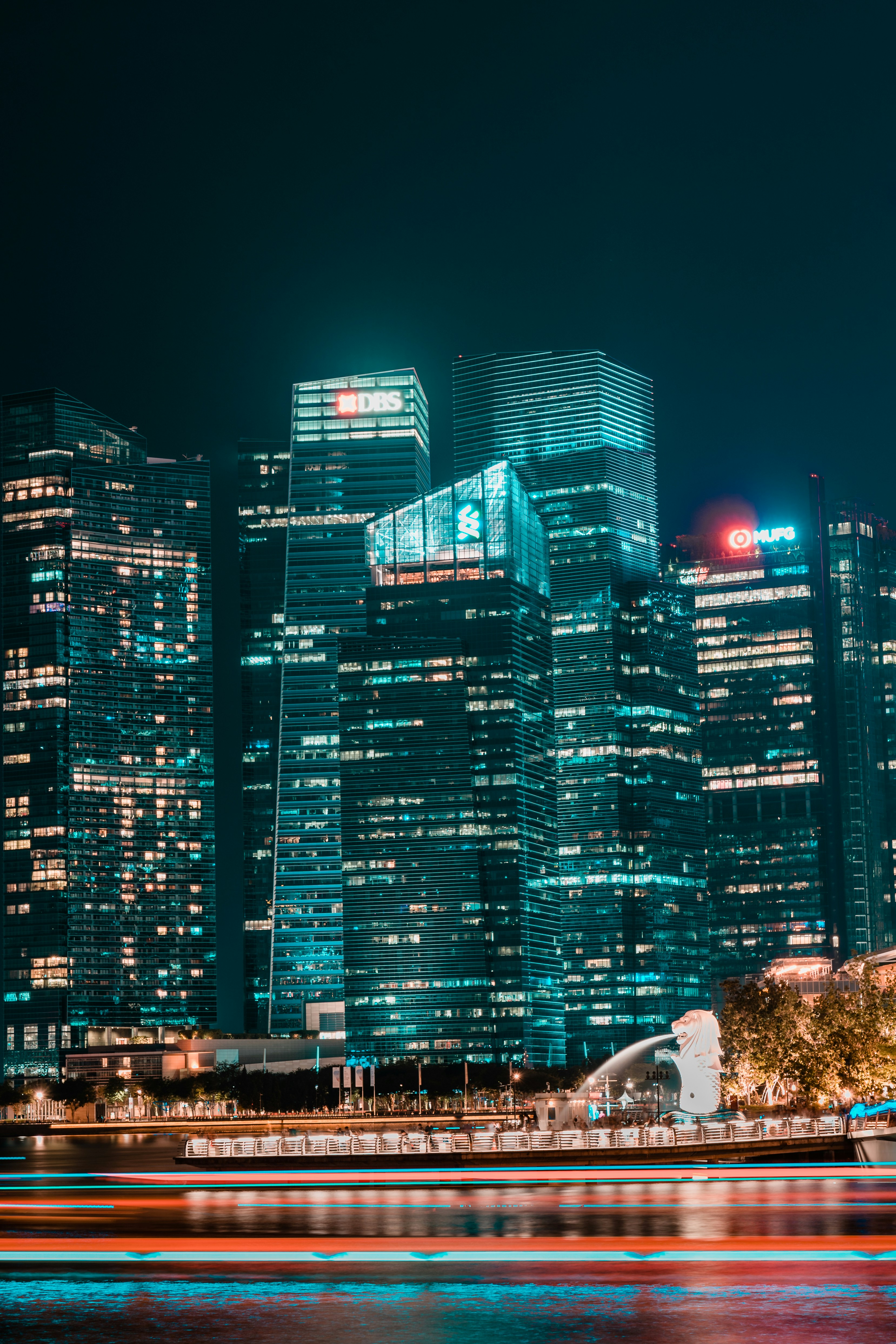 View photography of city high rise buildings during nighttime photo ...