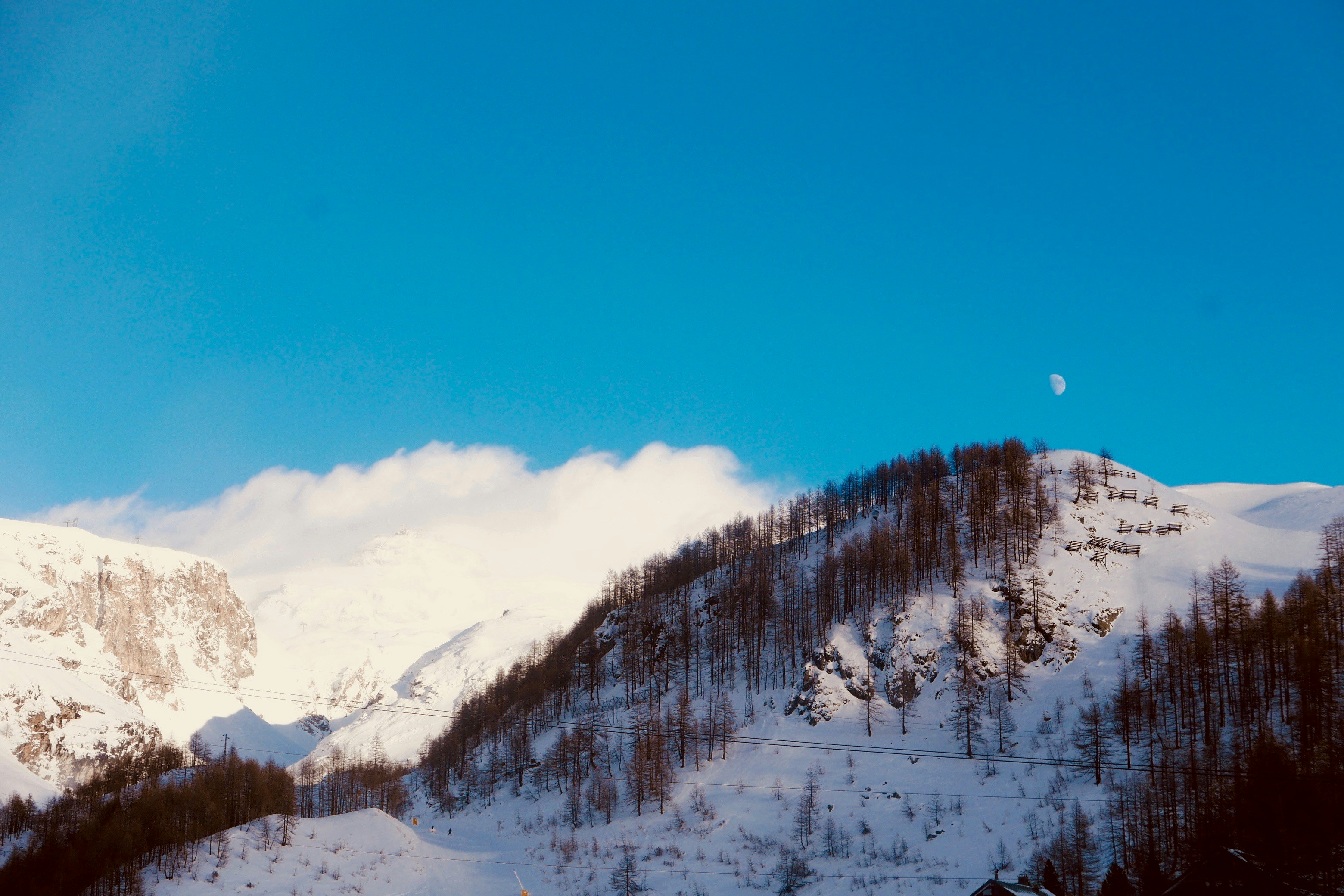 Moon Over the Frostbound Ridge Under a Clear Alpine Sky