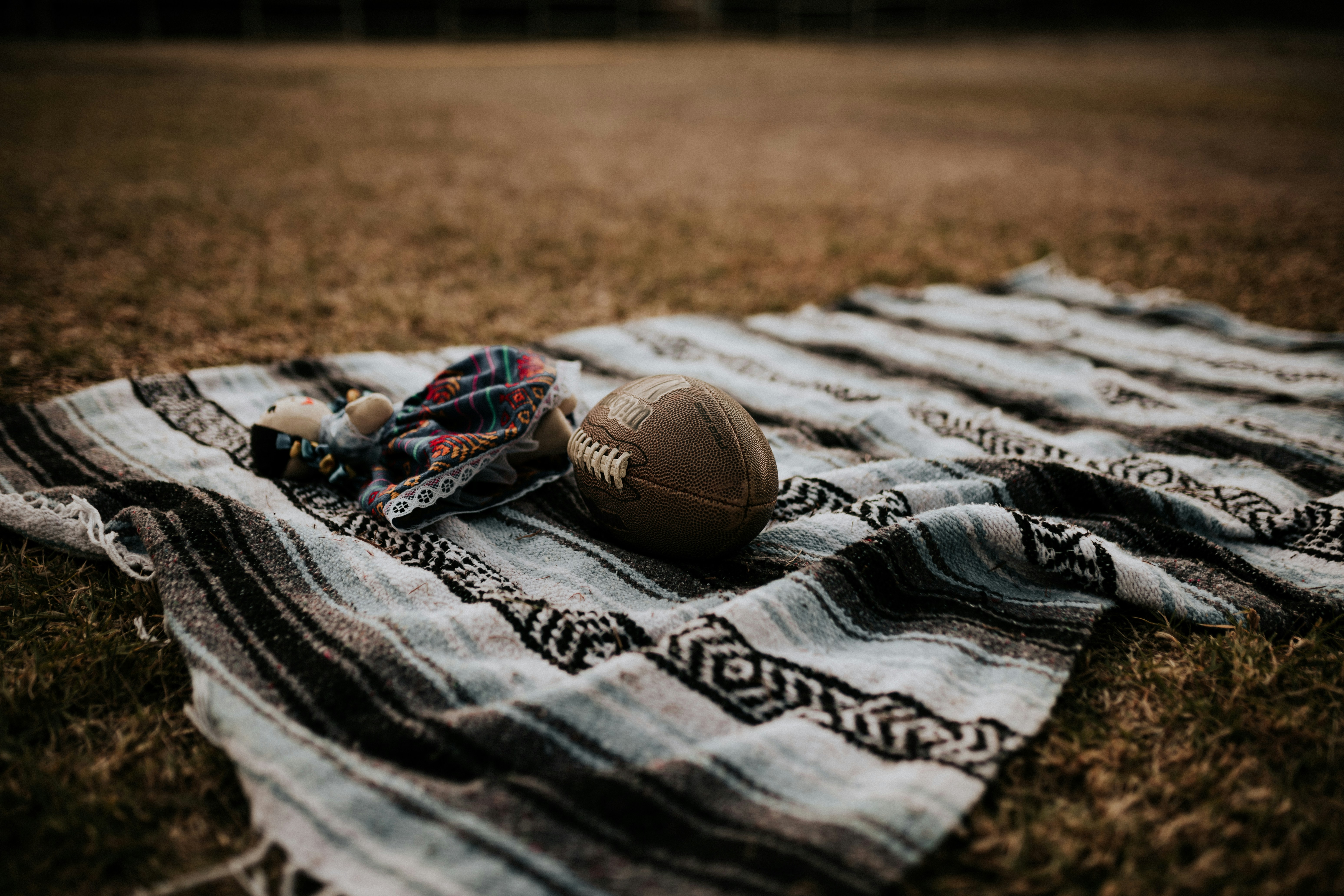 Lone Football on a Woven Blanket in Quiet Field Light