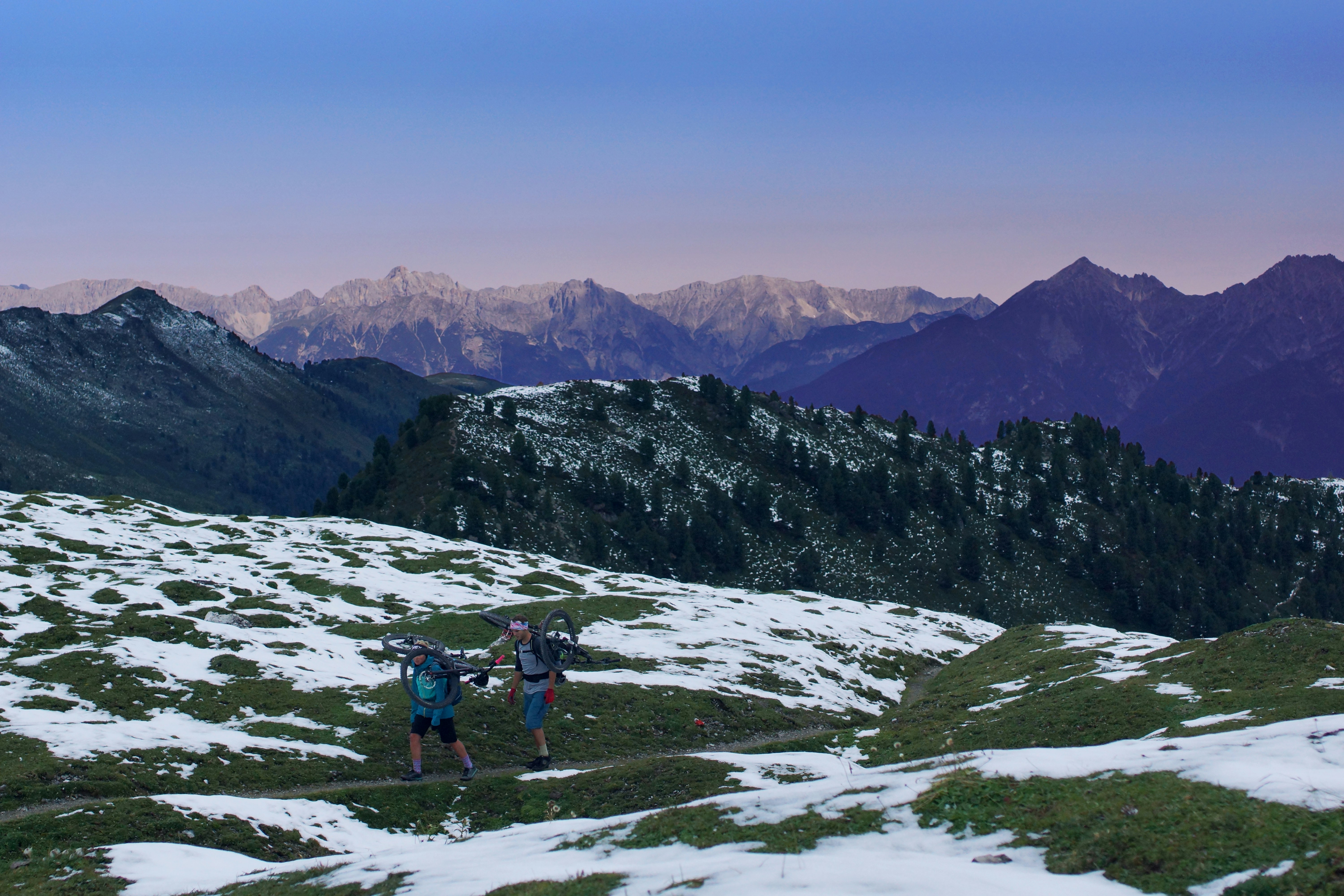 Snow-Dusted Ridge Run: Two Hikers Against Twilight Alpine Peaks