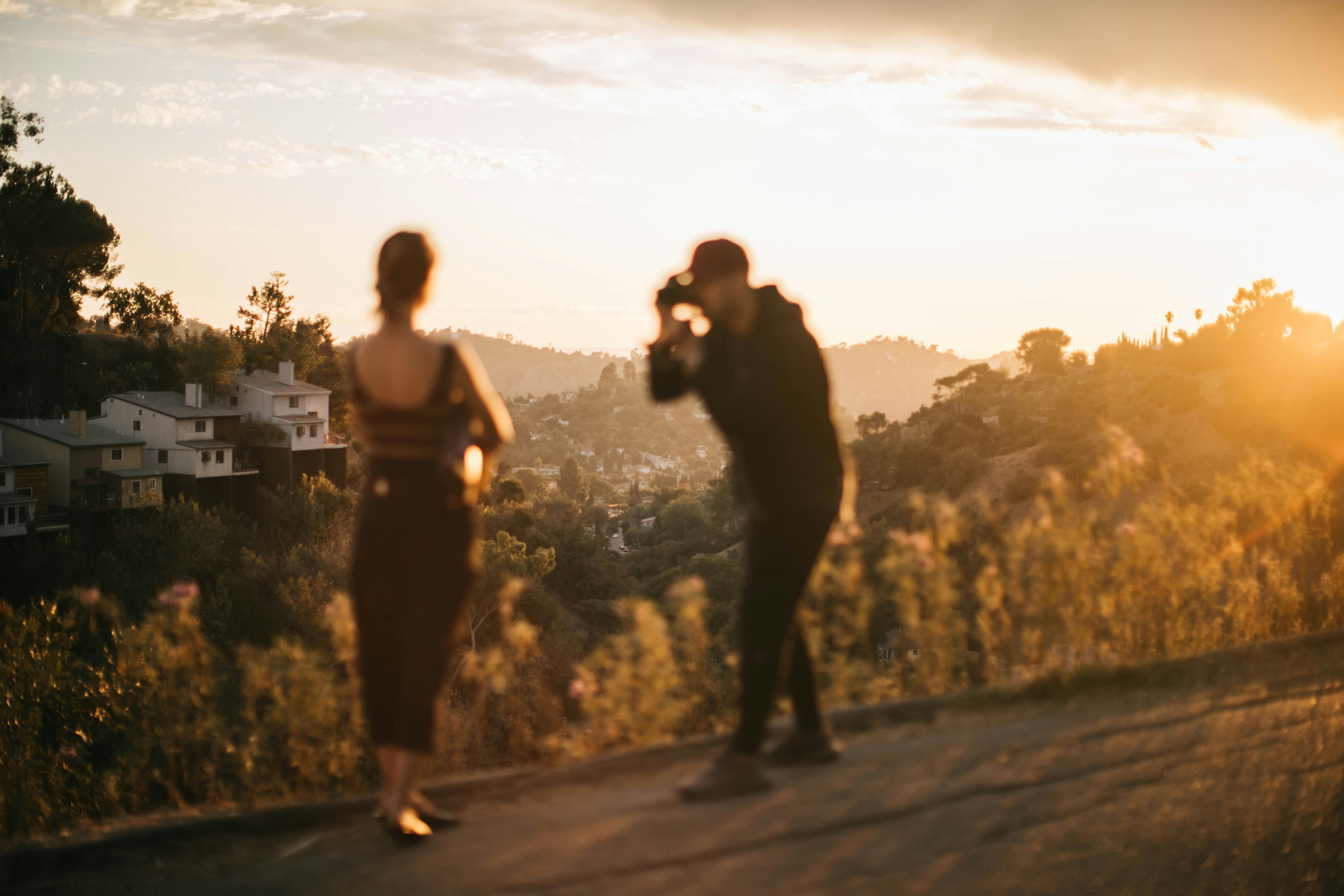 Silhouetted photographer capturing a model against a glowing sunset in East Los Angeles.