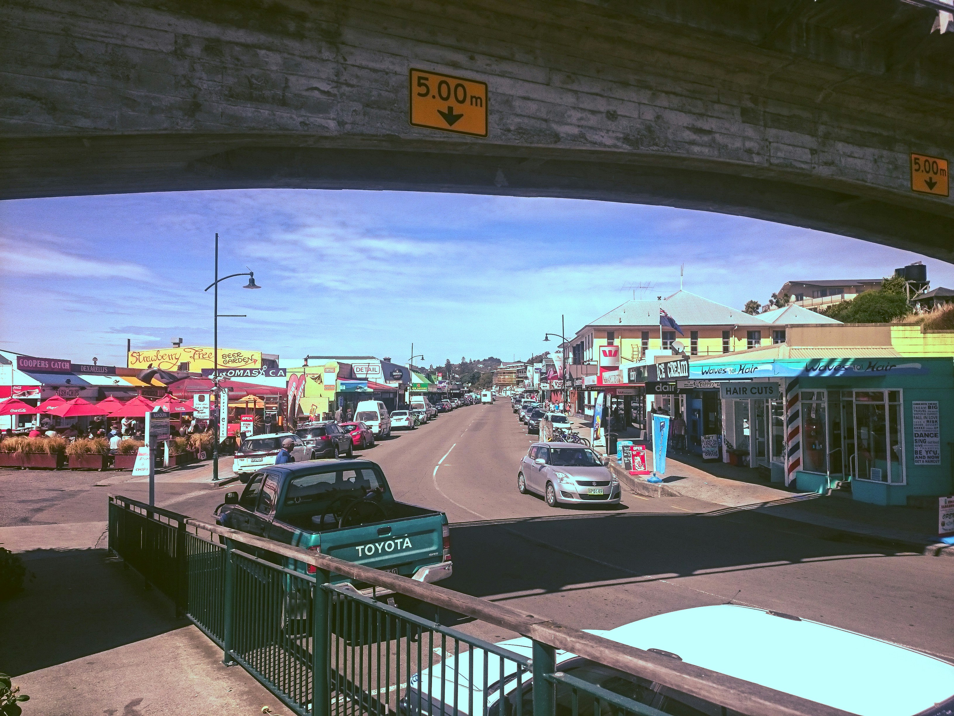 Sunlit Main Street Under the Overpass