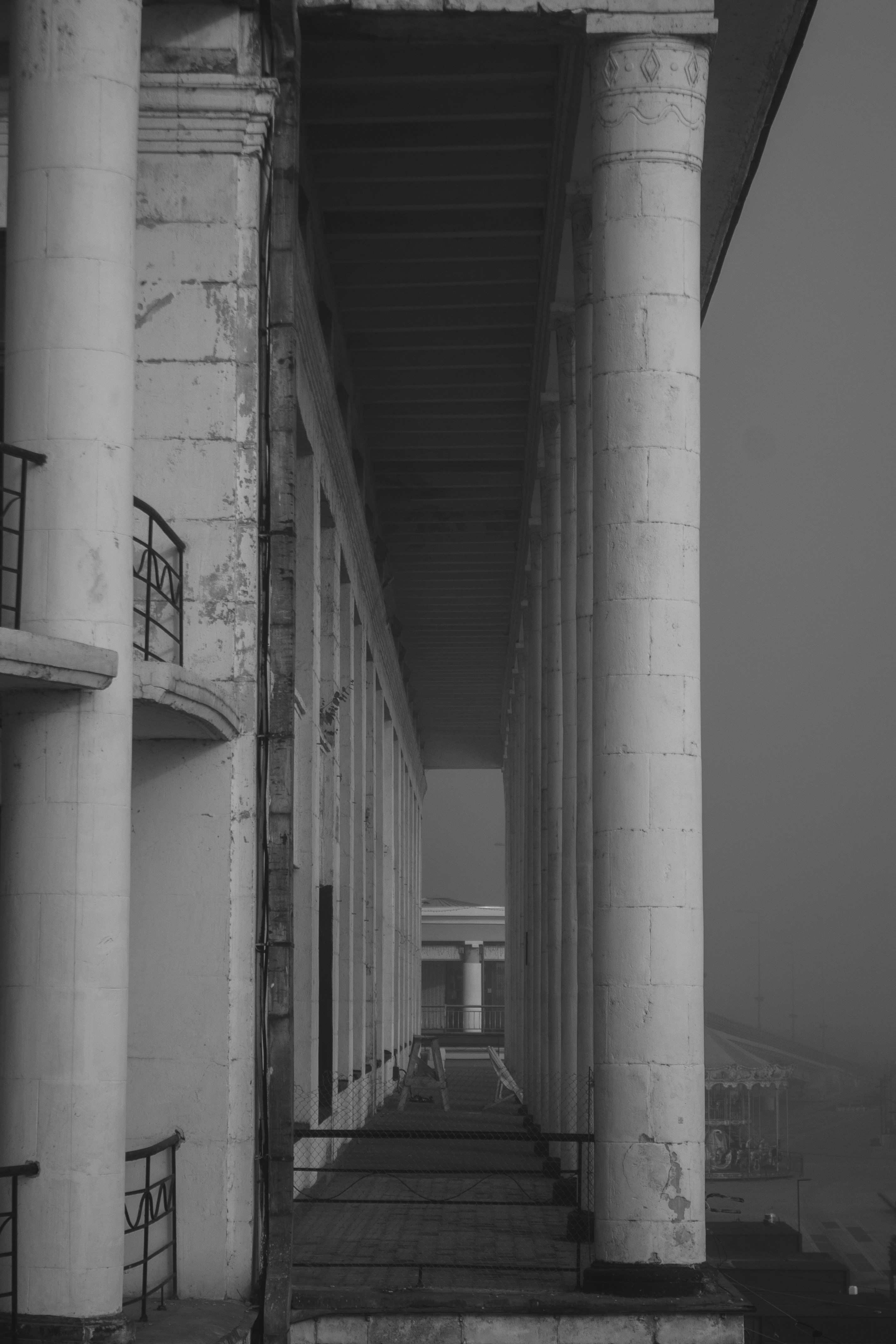 Vanishing Colonnade: A Monochrome Arcade Recedes into Mist