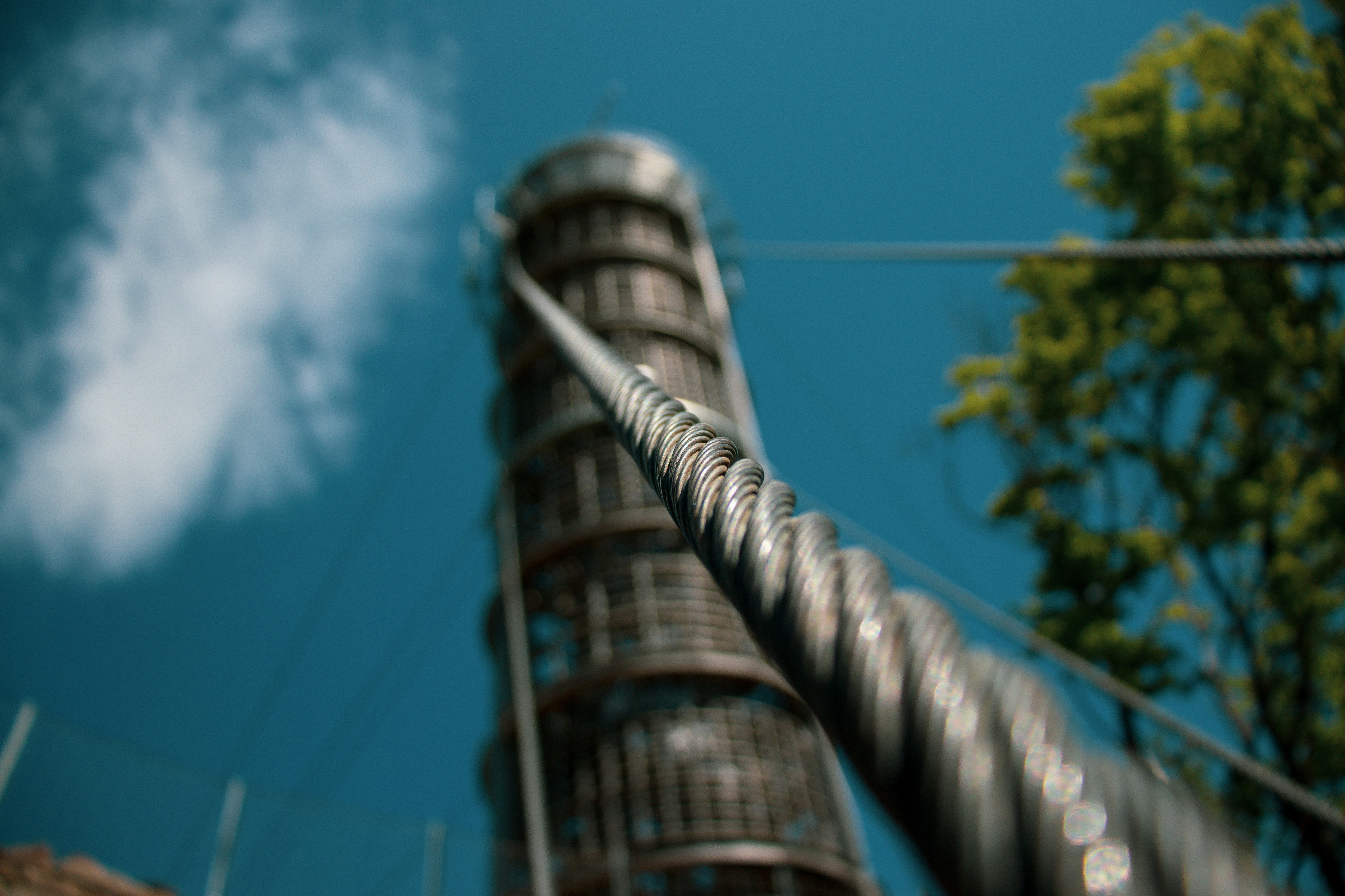 Tensioned Line: A Cable Leads the Way to a Towering Structure