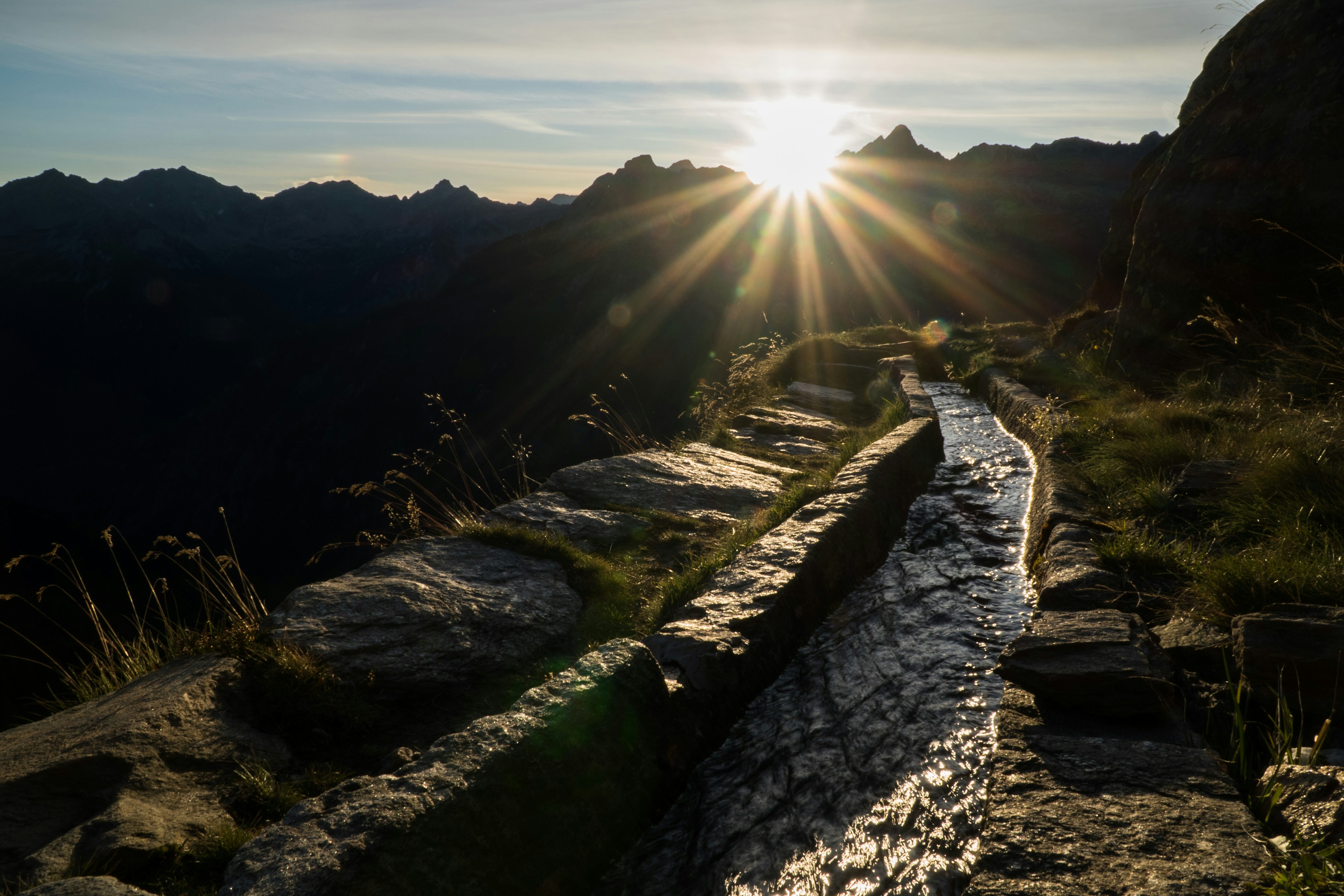 Sunlit Stone Path Clinging to the Mountain Ridge