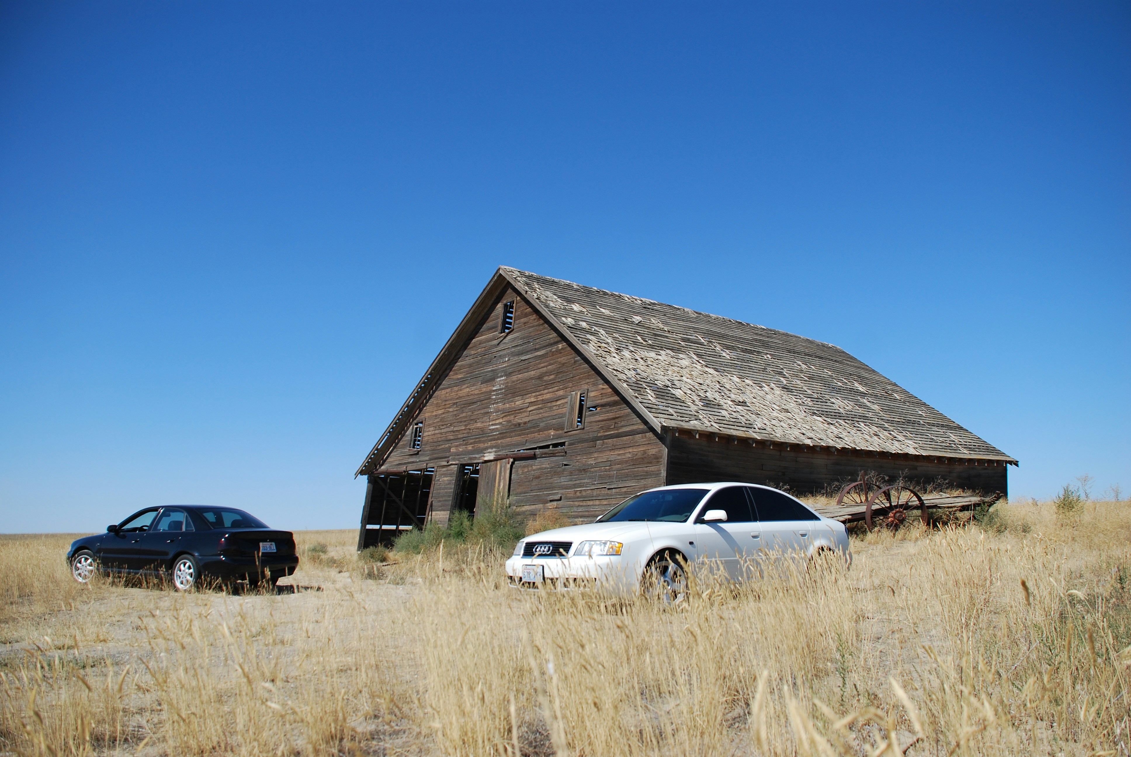 Silver Car, Weathered Barn, and a Quiet Prairie