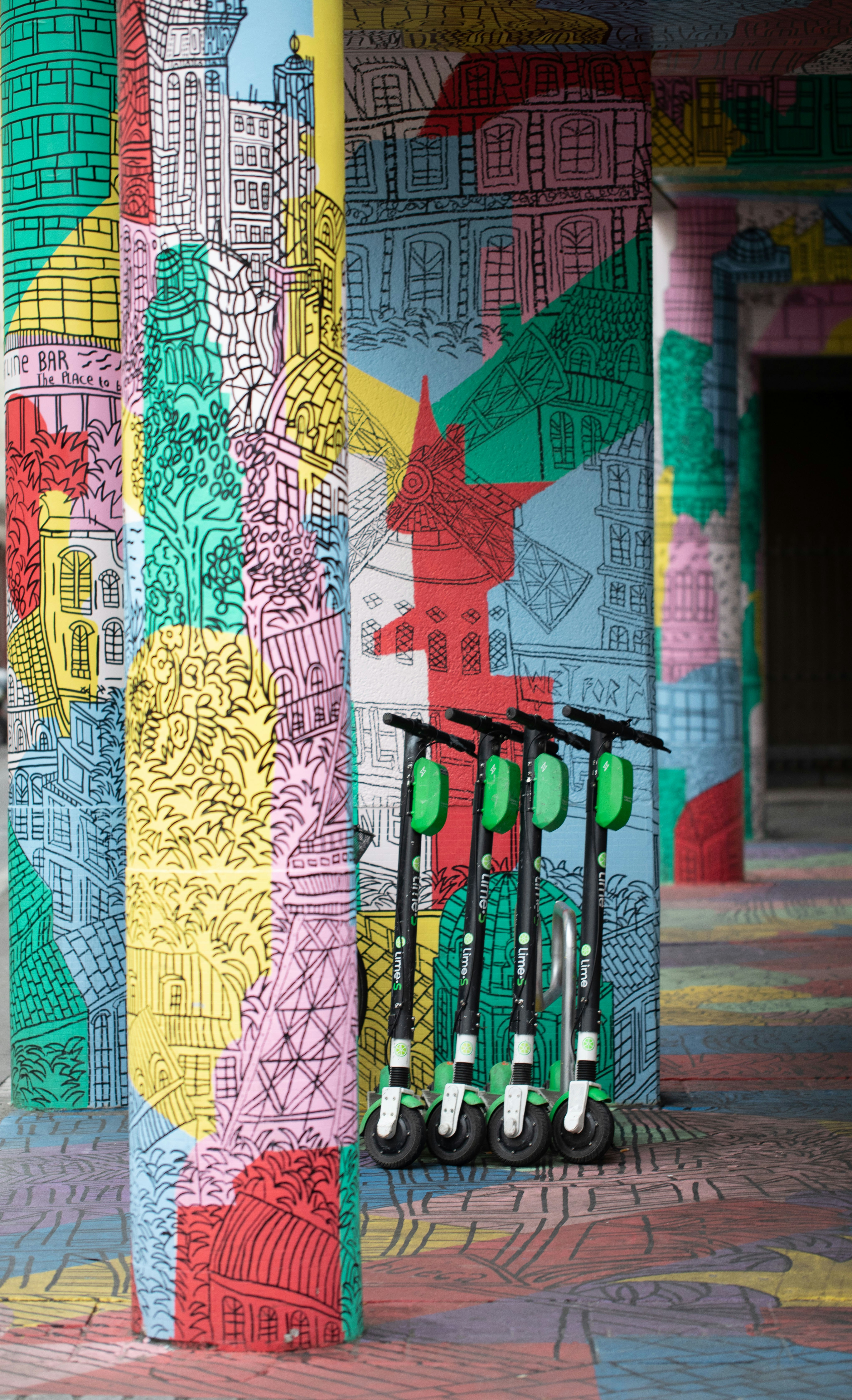 Neon Scooters Dock in a Kaleidoscope of City Graffiti
