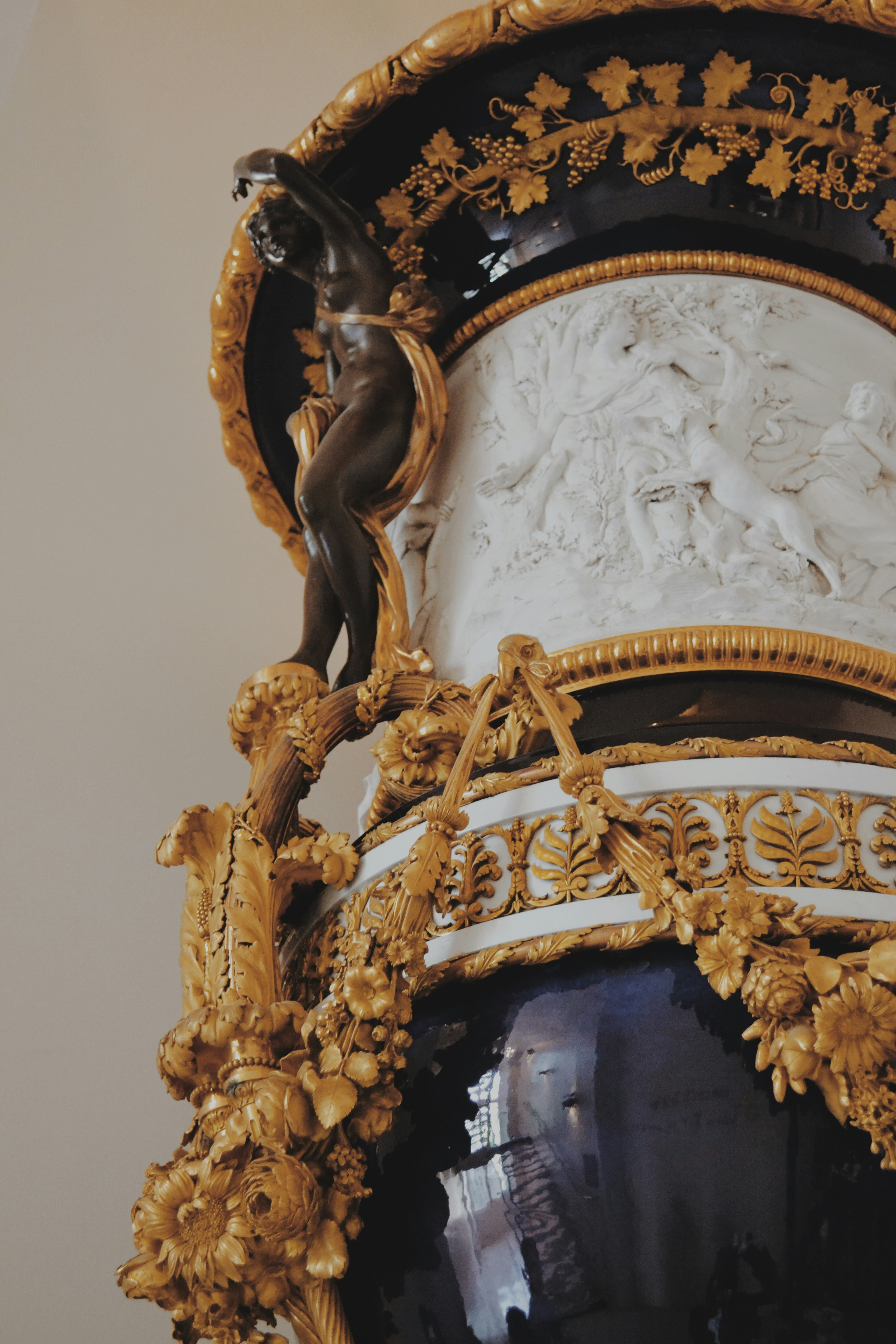 Ornate Urn: gilded scrollwork framing a classical relief
