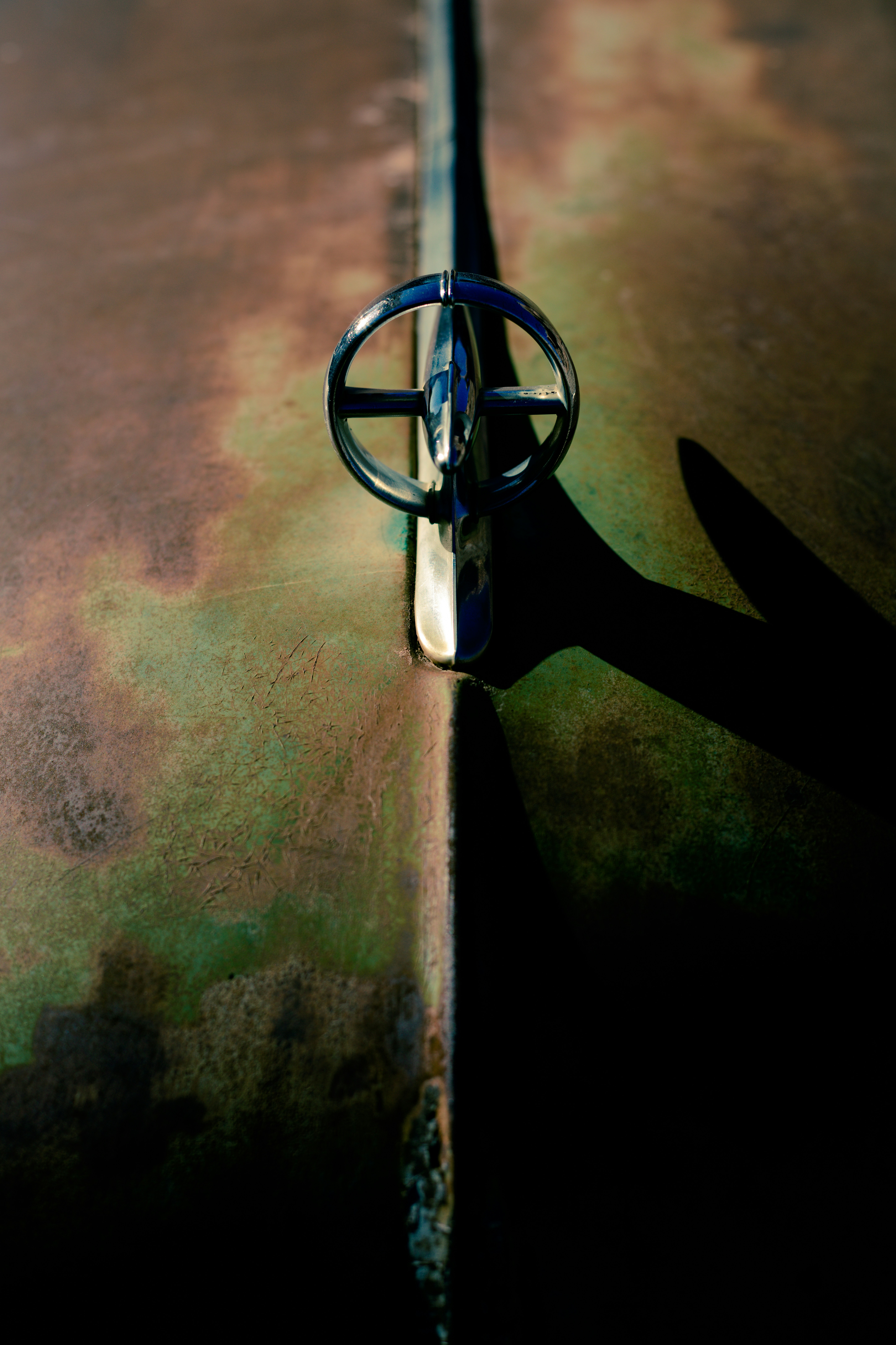 Circular Valve Against a Rusted Grid: Shadow Cast on a Silent Surface