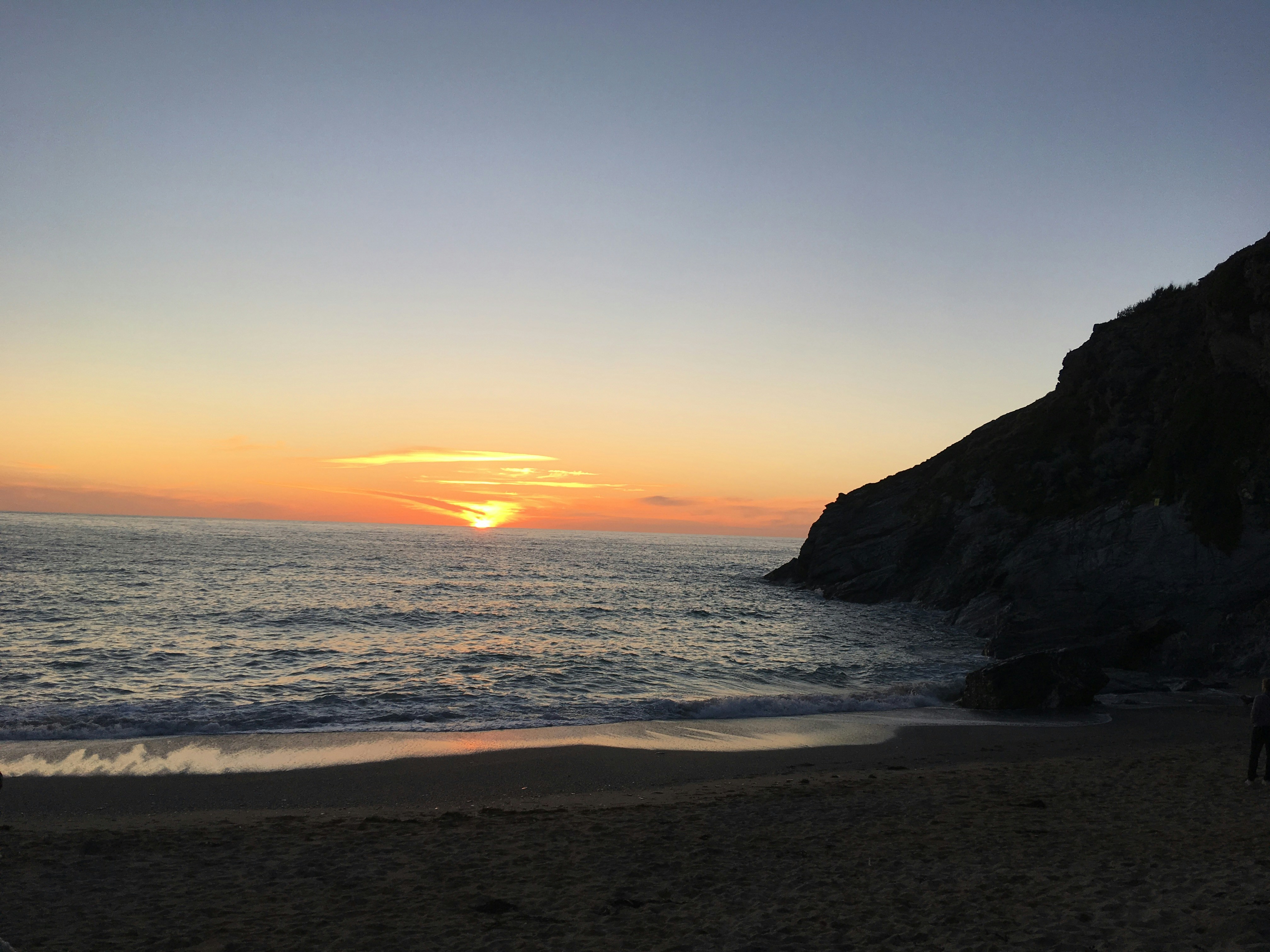 Sunset at the Cove: A Golden Sliver Between Sea and Cliff