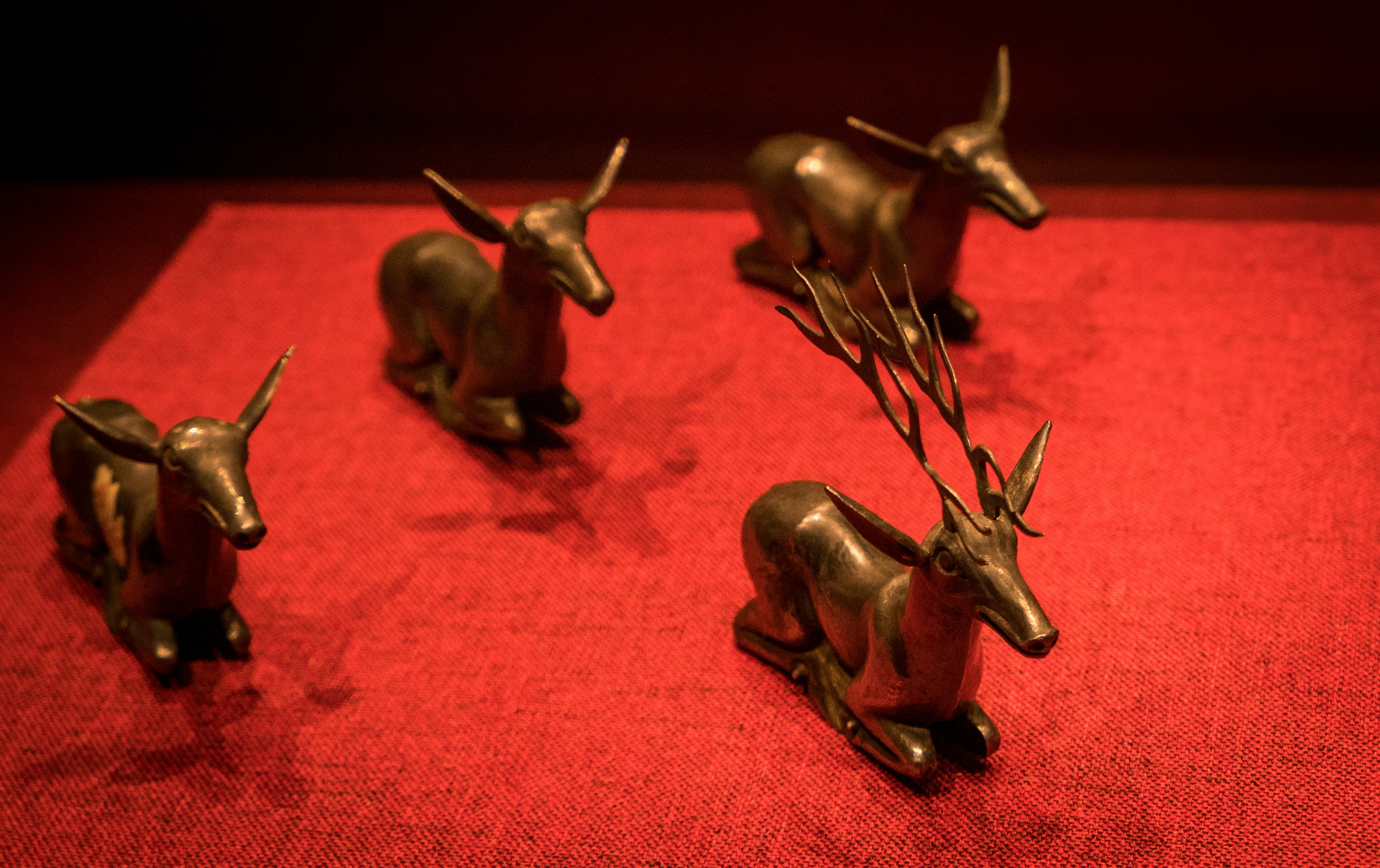 Brass Flock of Antlered Statues on a Velvet Red Table