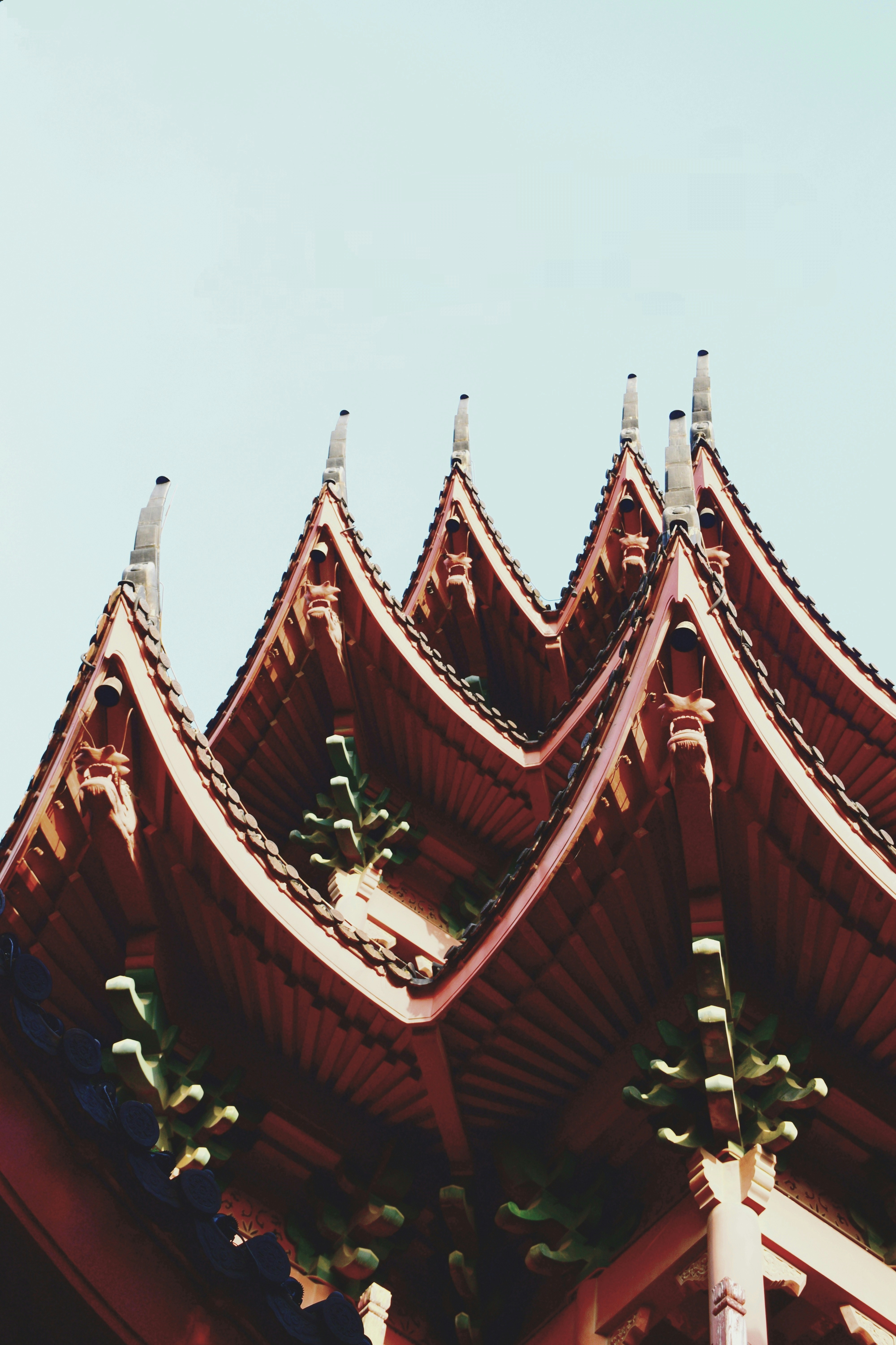 Crimson Crown: A Row of Temple Roof Peaks Against a Cerulean Sky