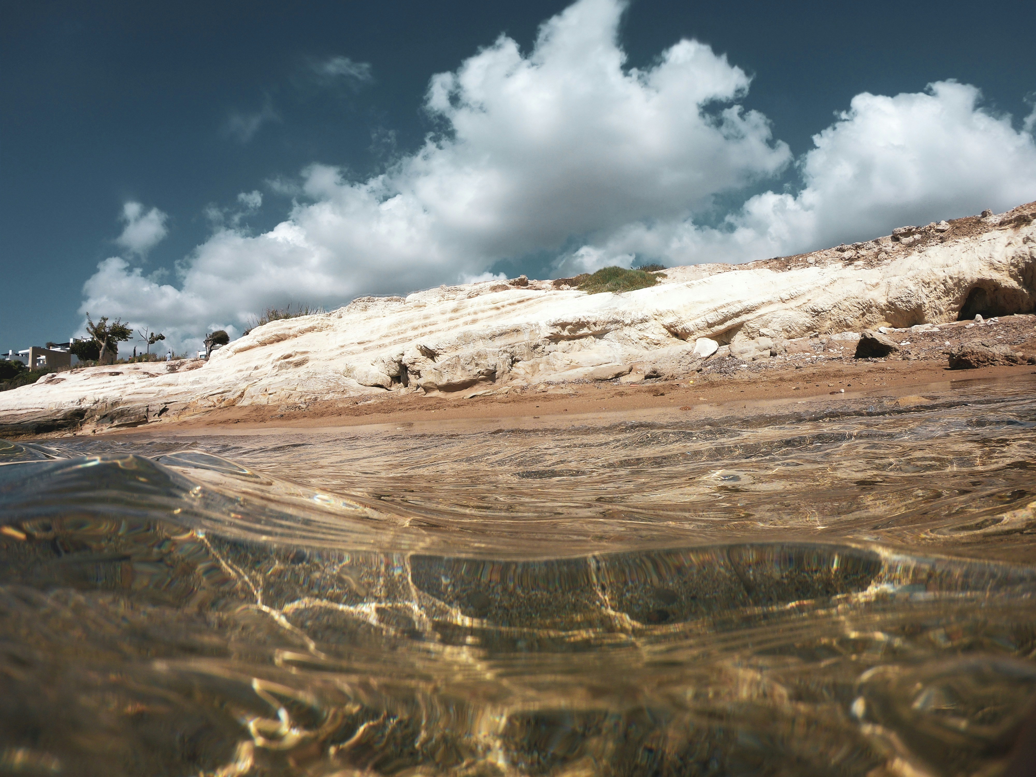 Half-Under, Half-Over: Light-Ripple Patterns Along a Sunlit Beach Cliff