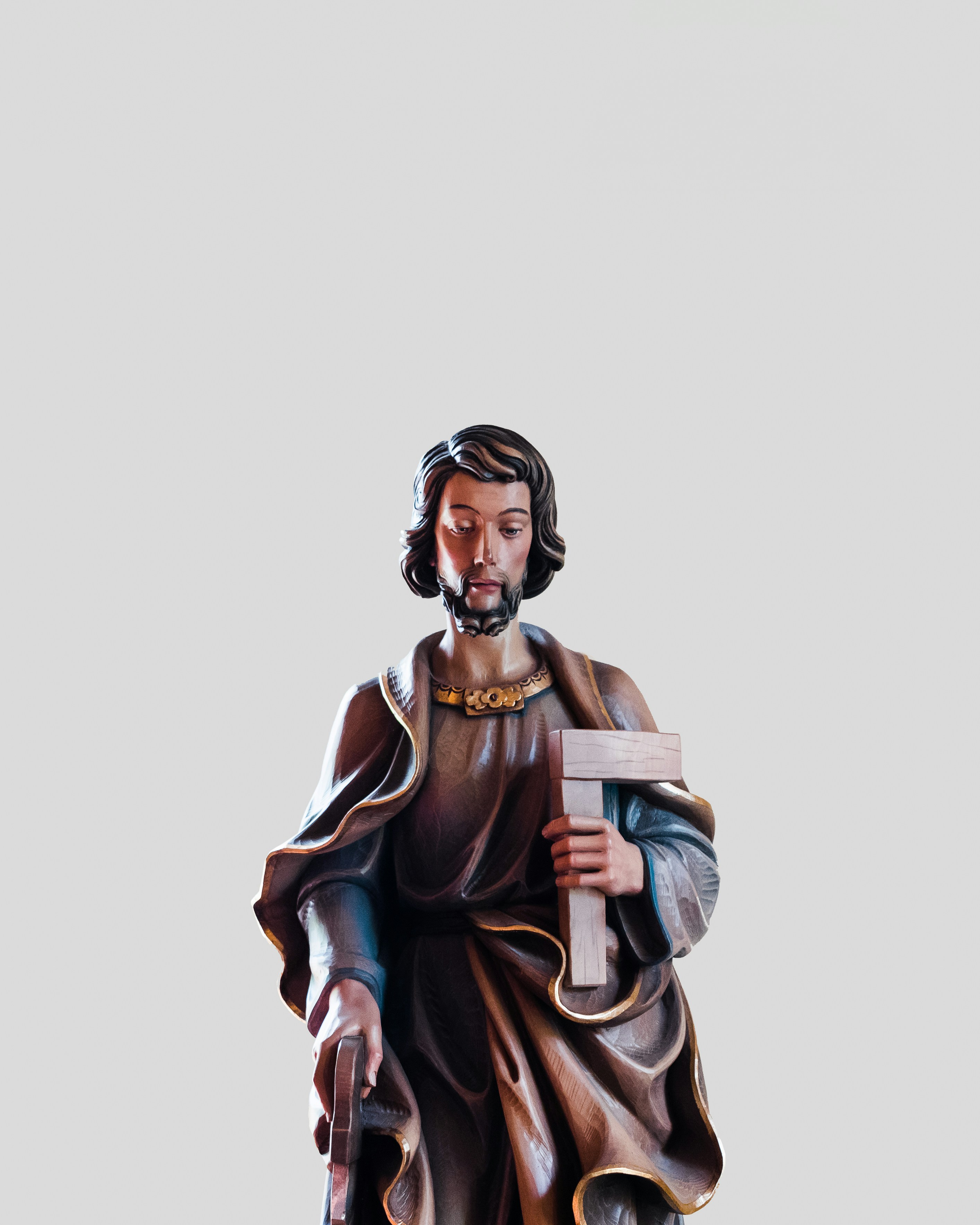 Quiet Light on a Carved Saint: Jesus Holding a Cross