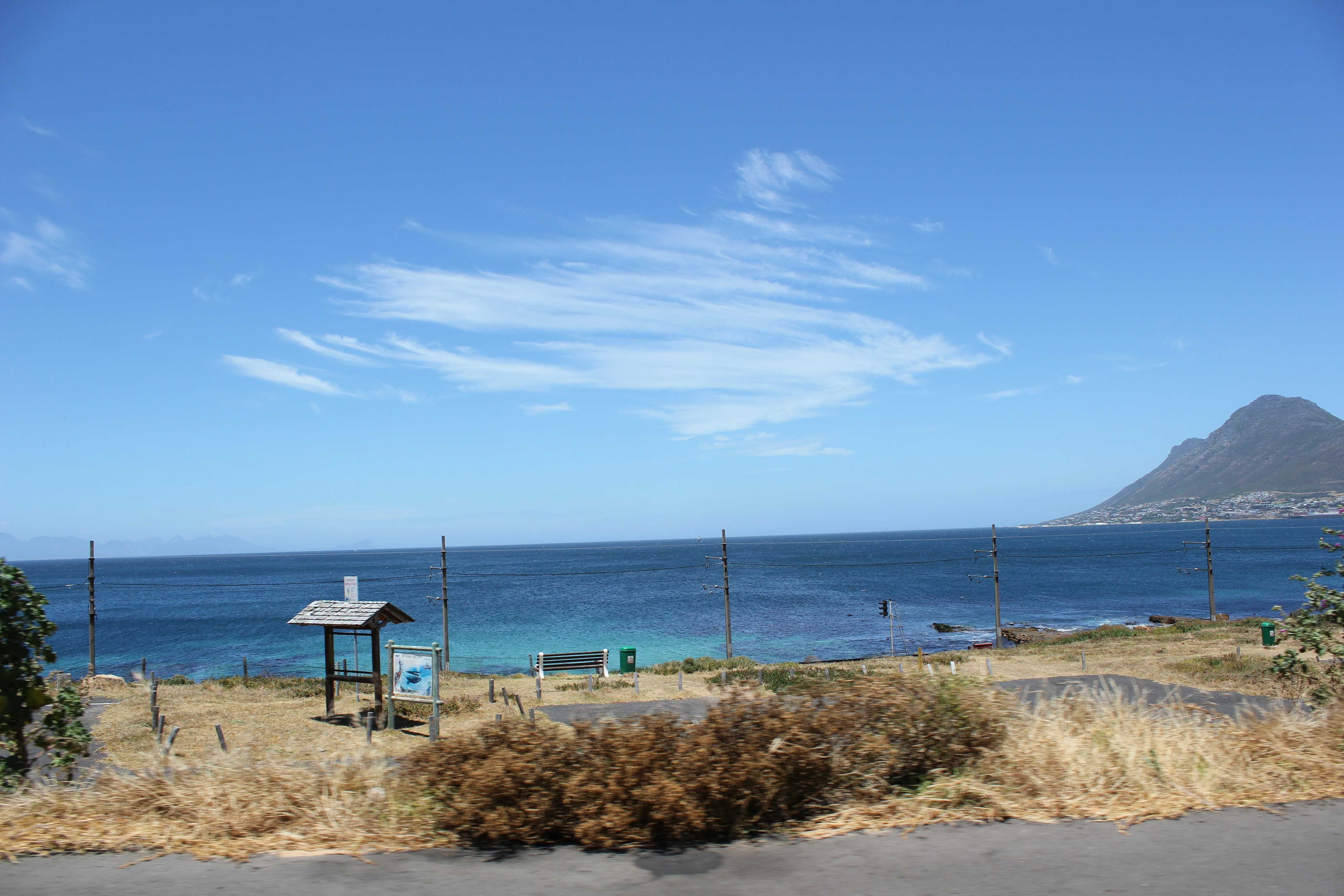 Shoreline Shelter Amid Golden Grass and a Pristine Blue Sea