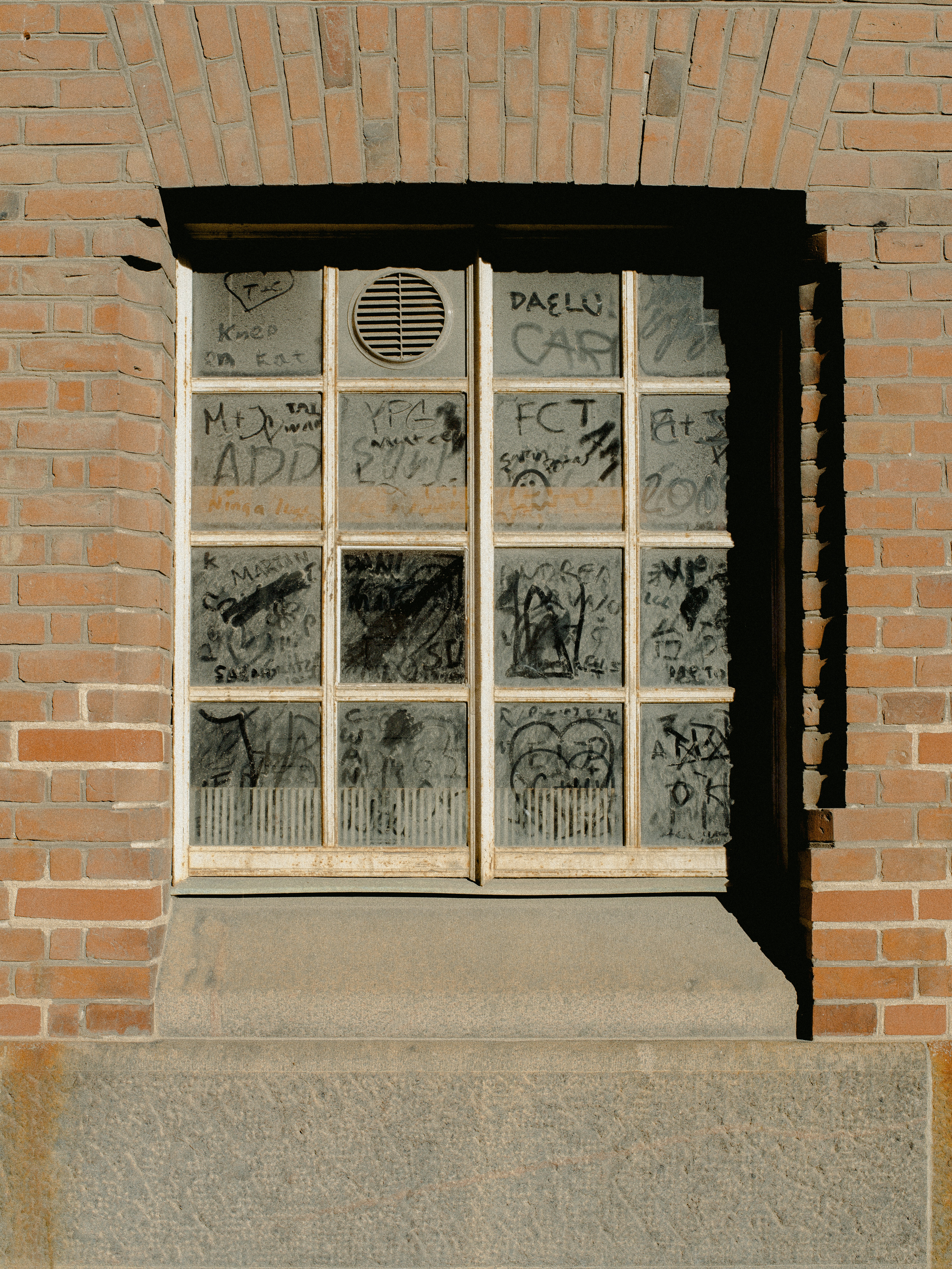 Dusty window that's been written on by passers by