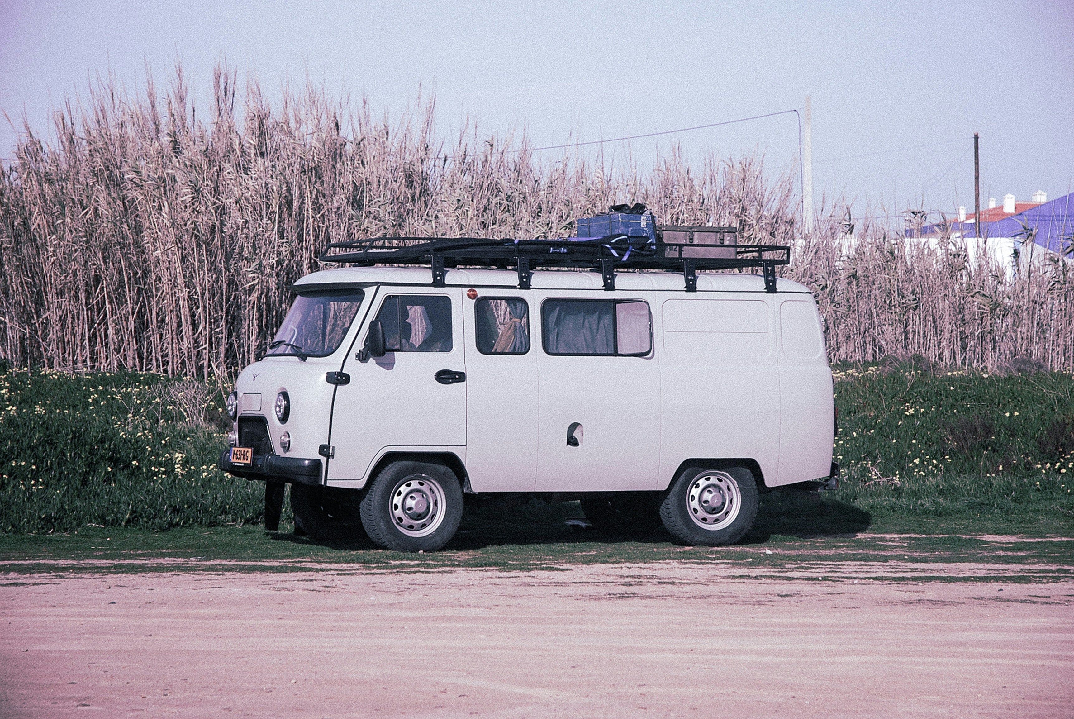 Vintage van parked amidst tall grass, evoking a sense of adventure and exploration.