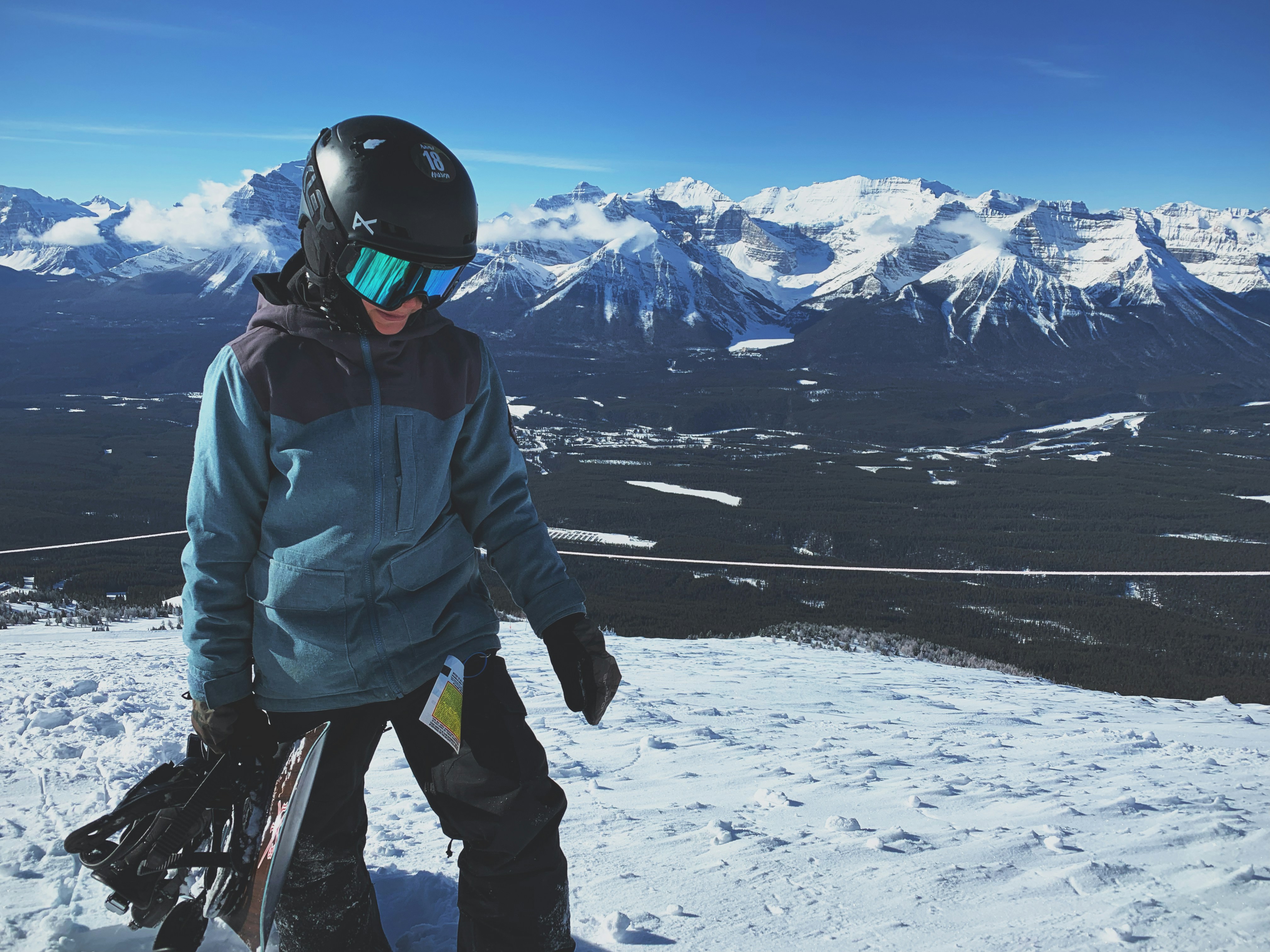 Person on snow-capped mountain wearing helmet and snow goggles photo ...