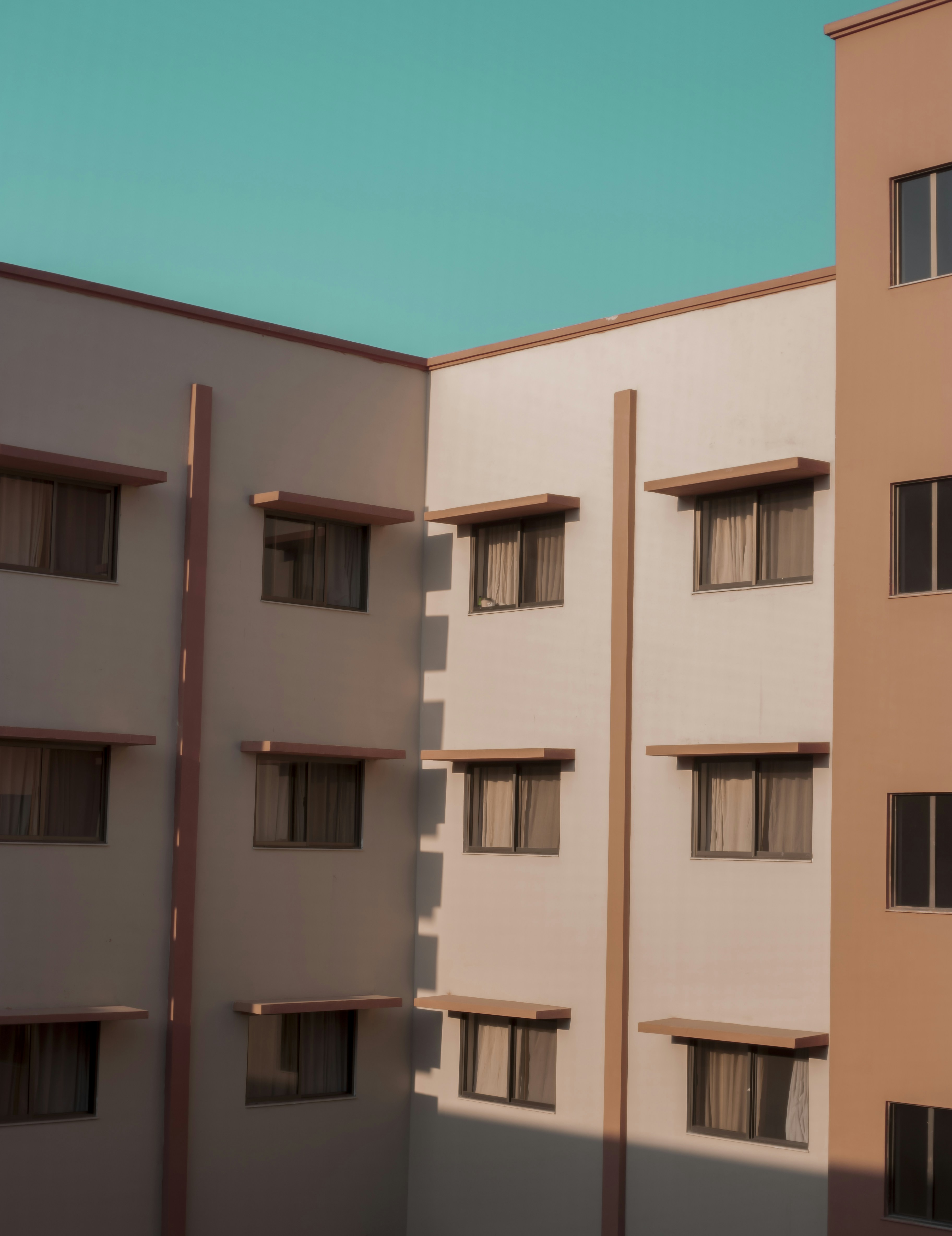 Pastel Facade Geometry Under a Turquoise Sky