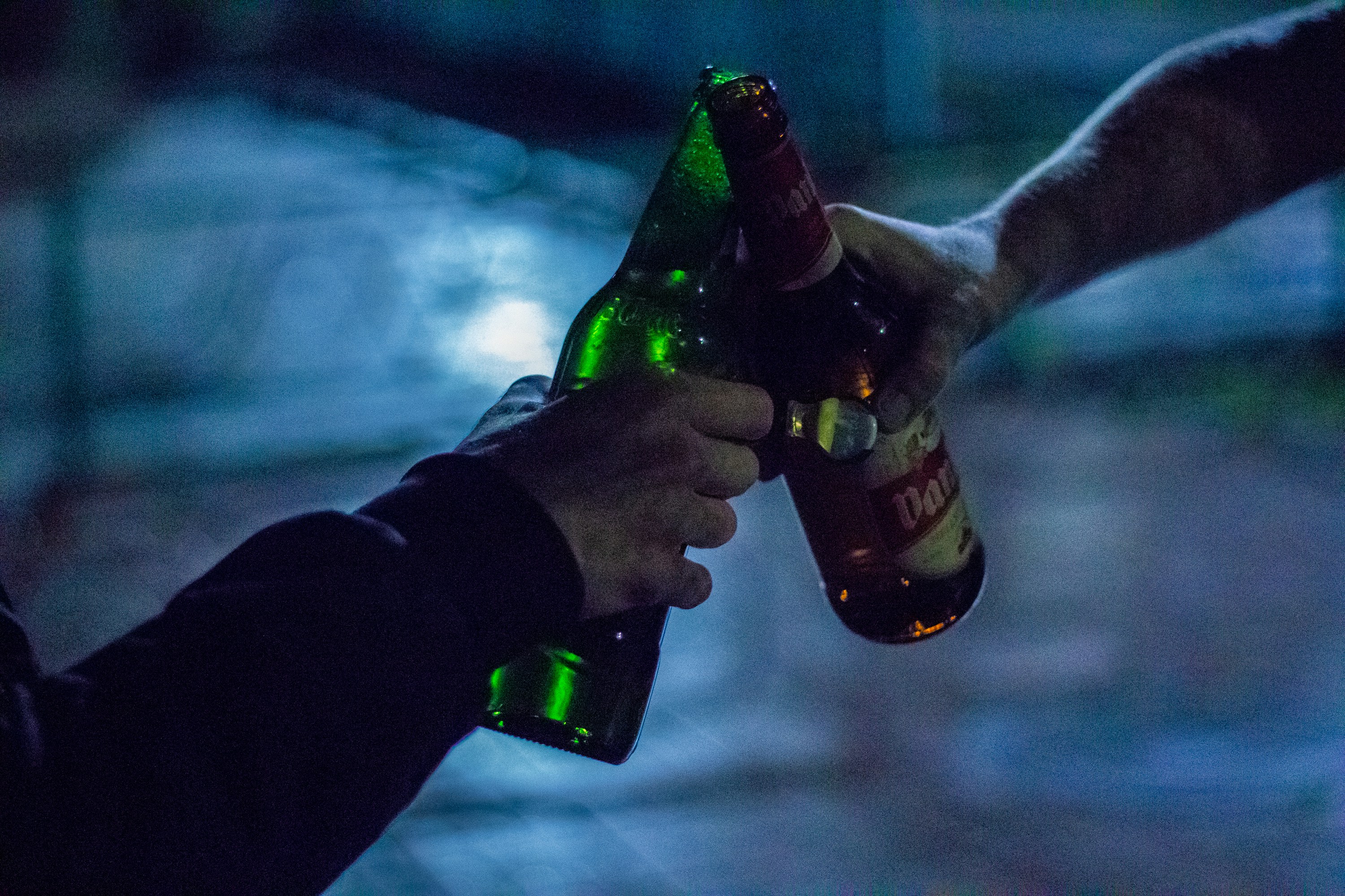 Bottles Clink in a Dim Night Scene