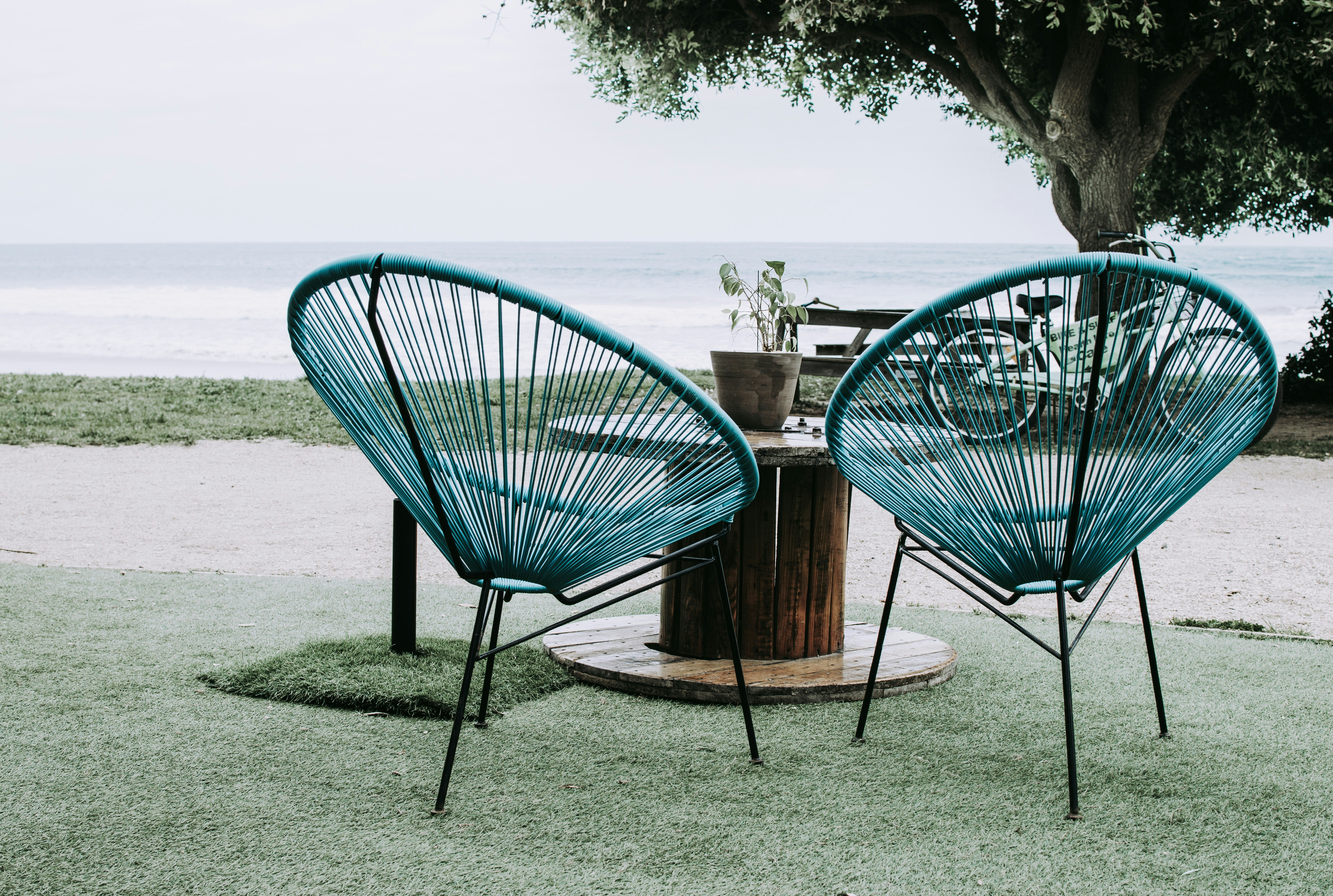 Two blue chairs beside round table near ocean photo – Free Grey Image ...