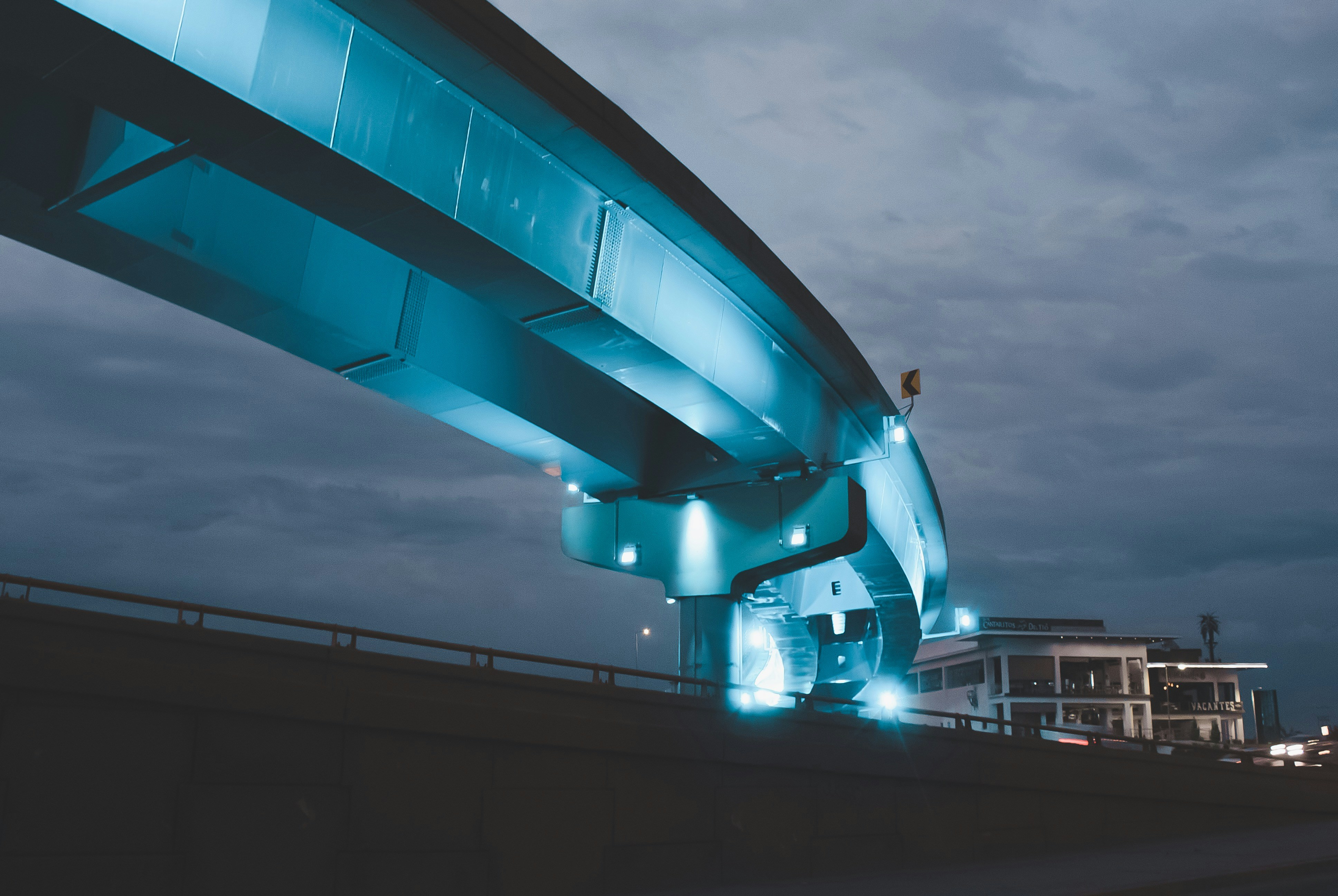 Neon Arc: A Blue Highway Rises Over Quiet Night