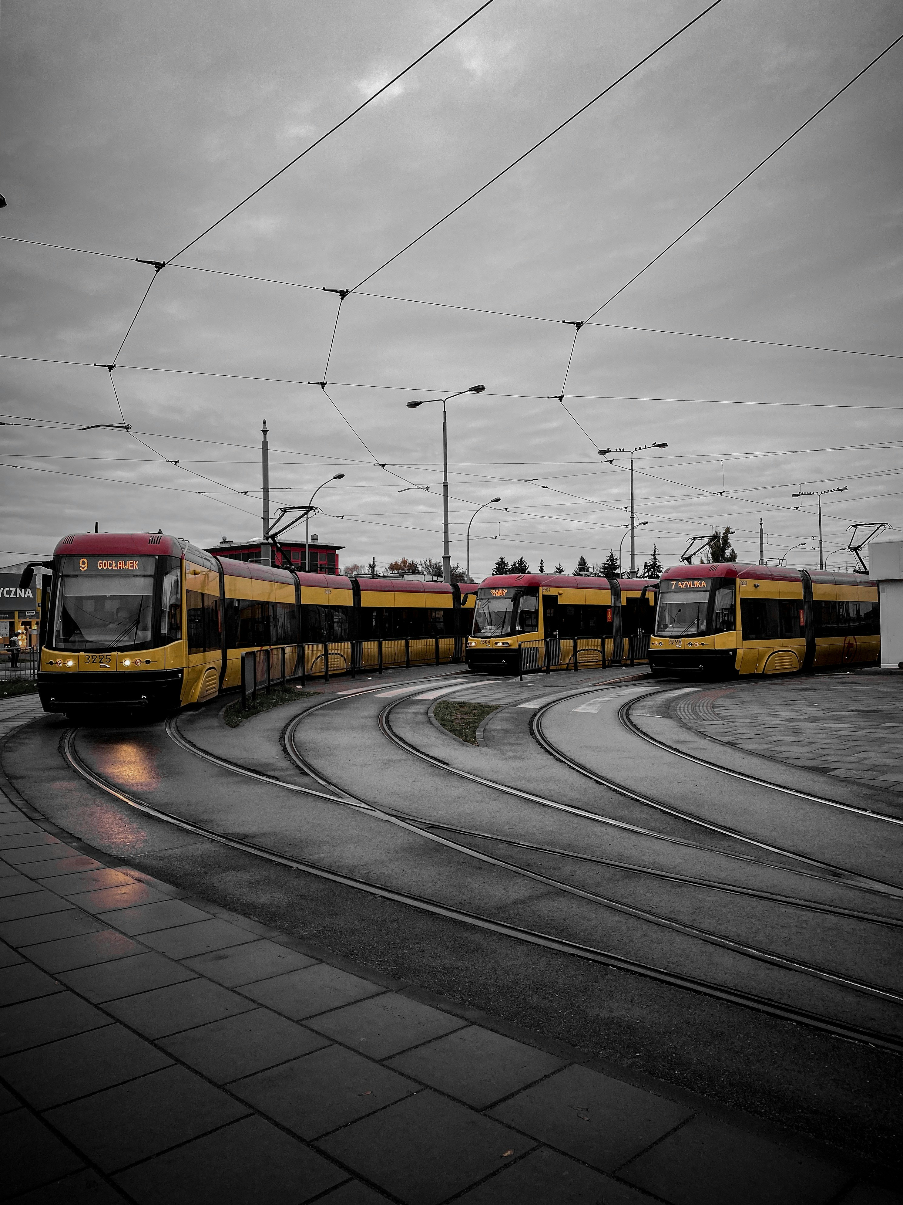three yellow-and-black trains on track