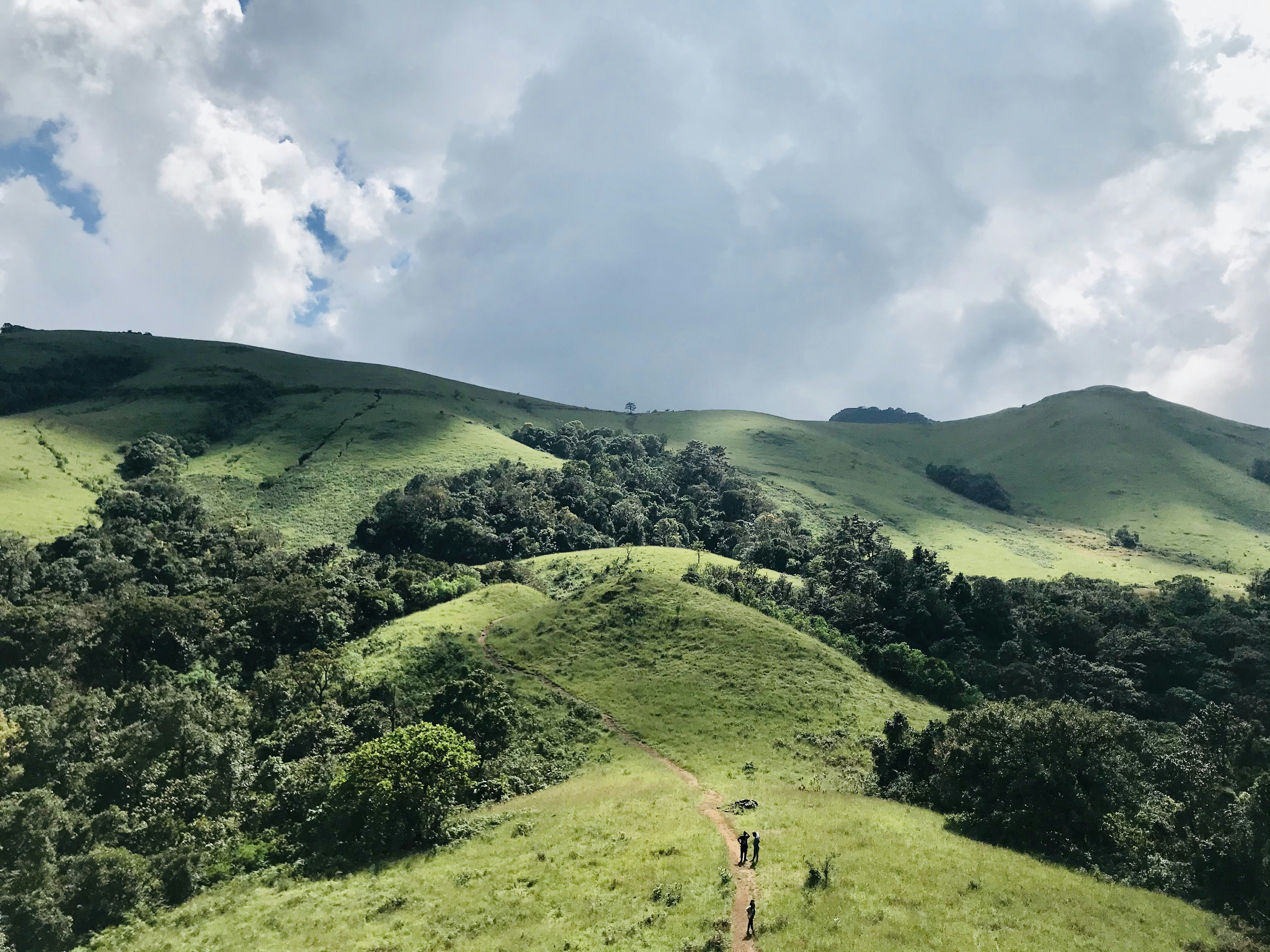 Rolling green hills under a sky filled with dynamic clouds.
