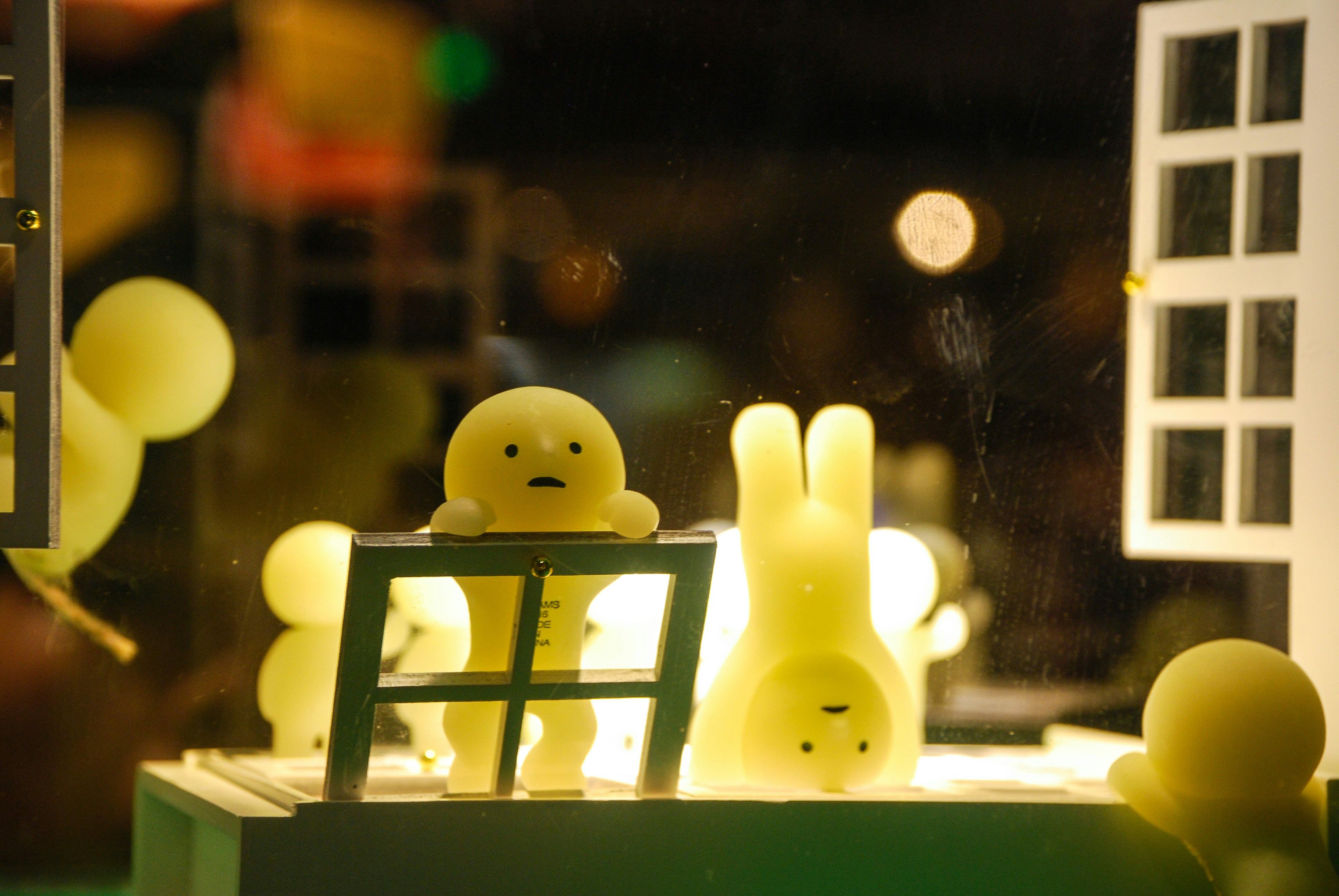 Glow-Soft Figures in a Night Window