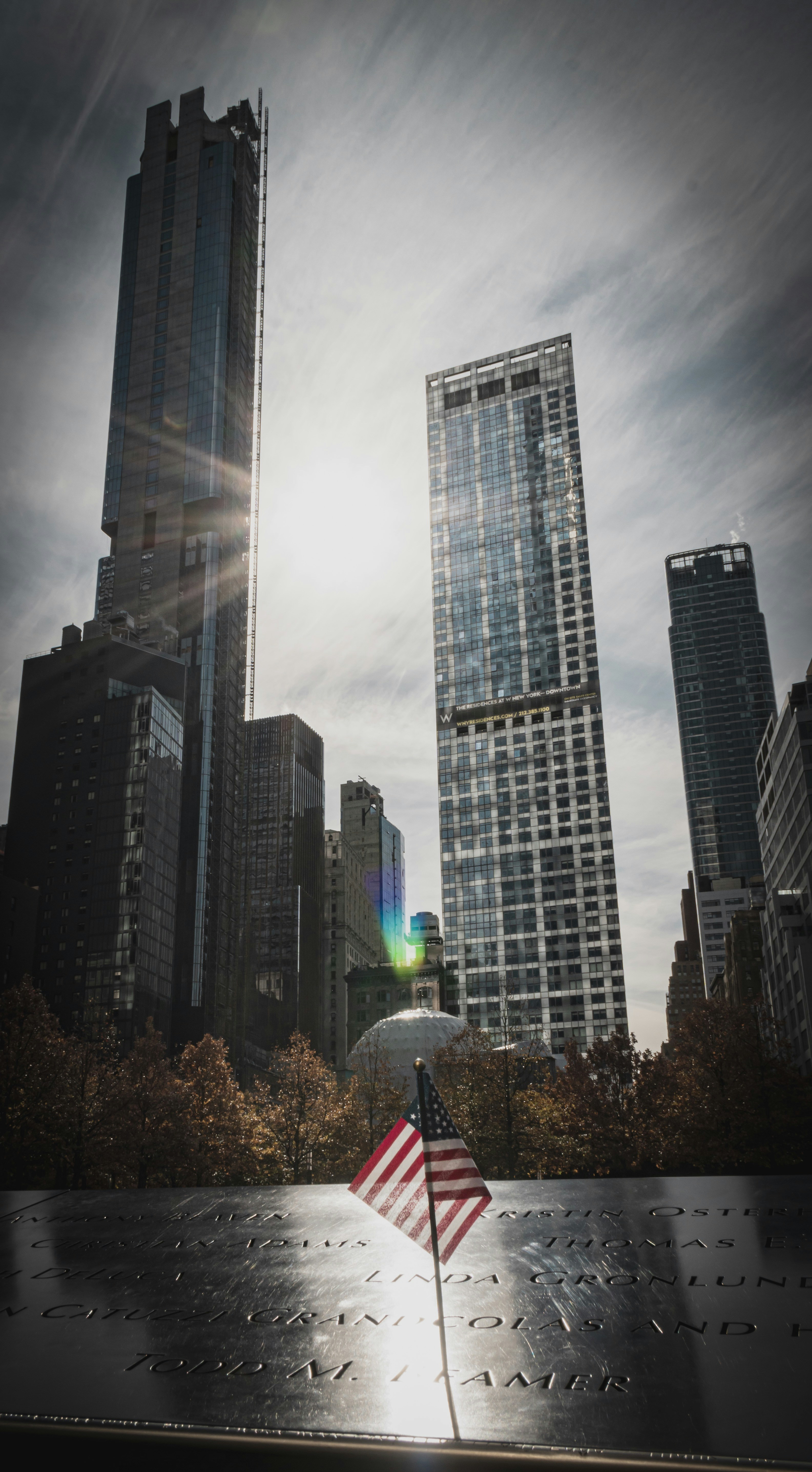 Sunlit Skyscrapers Behind a Reflective Memorial
