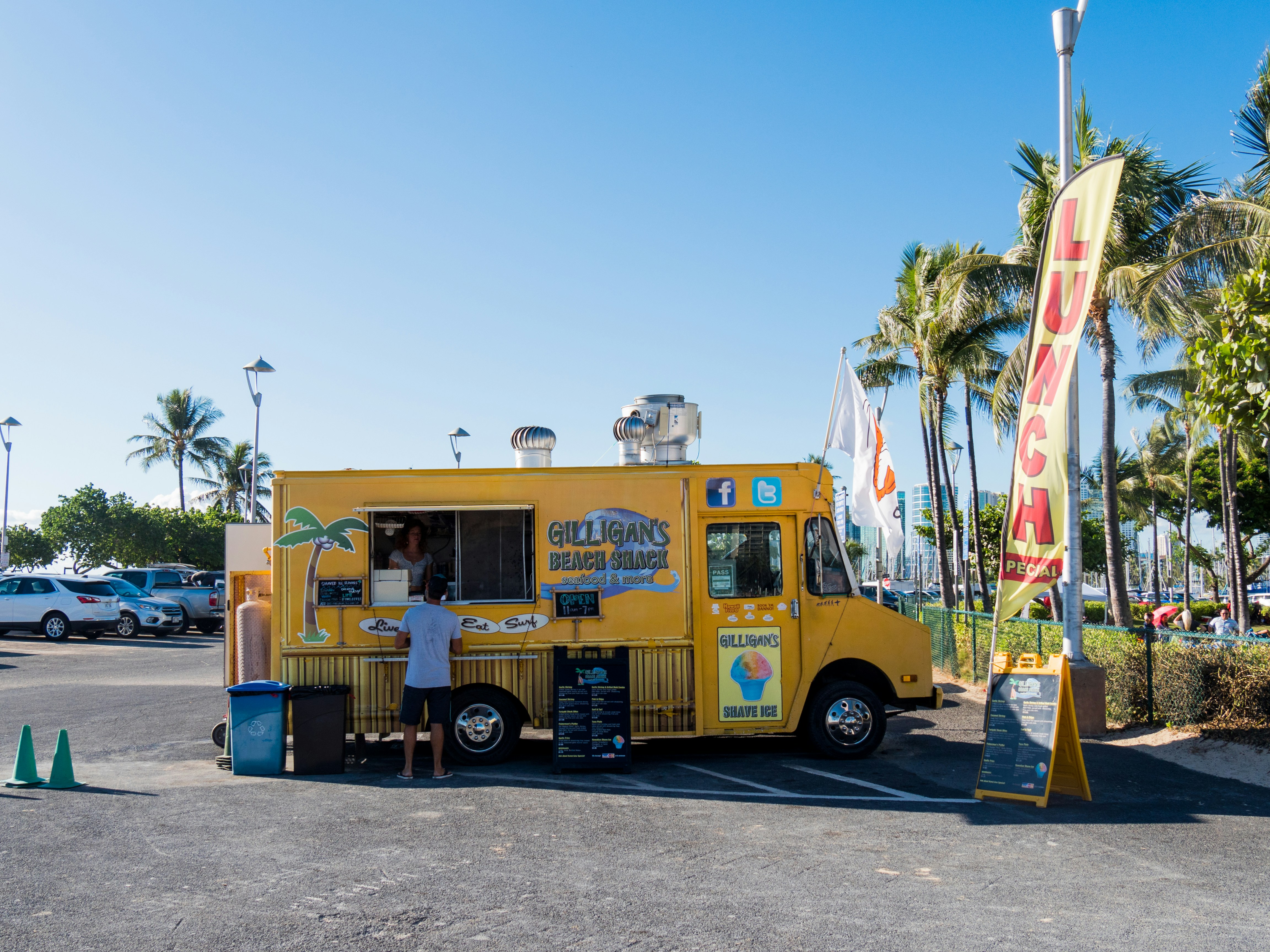Yellow multi-stop truck in parking lot photo – Free Person Image on ...