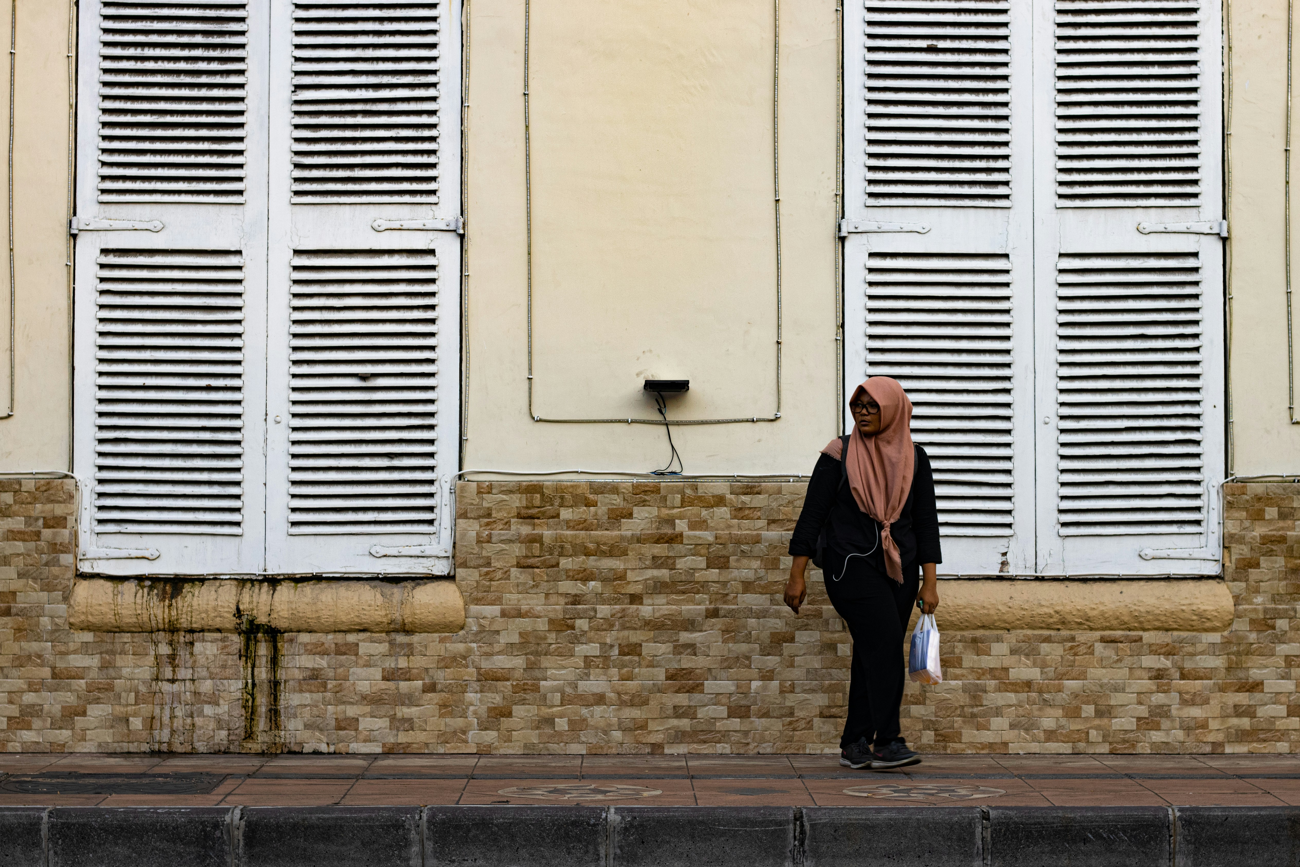 Quiet Street Portrait by a Shuttered Facade