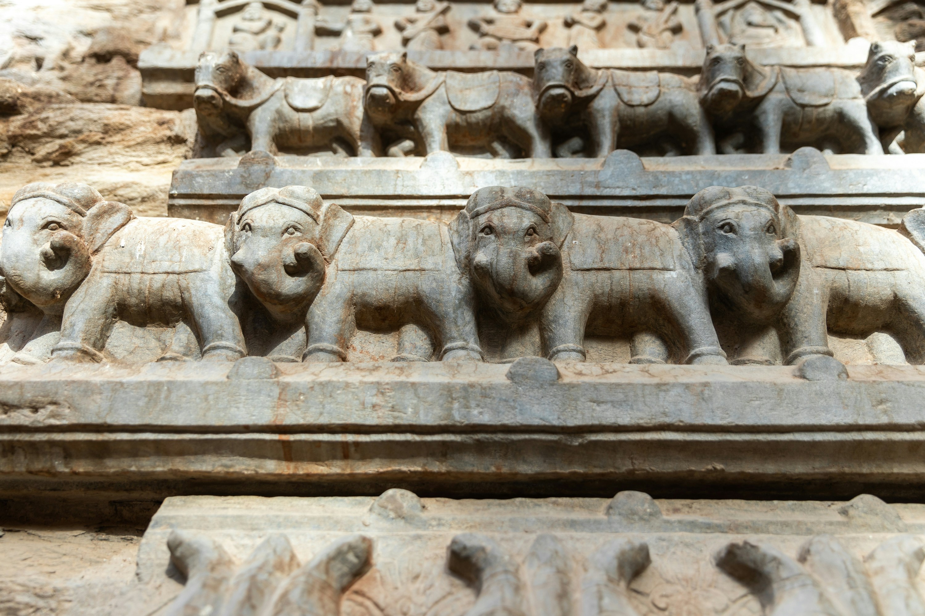gray concrete elephant statues on brown concrete wall