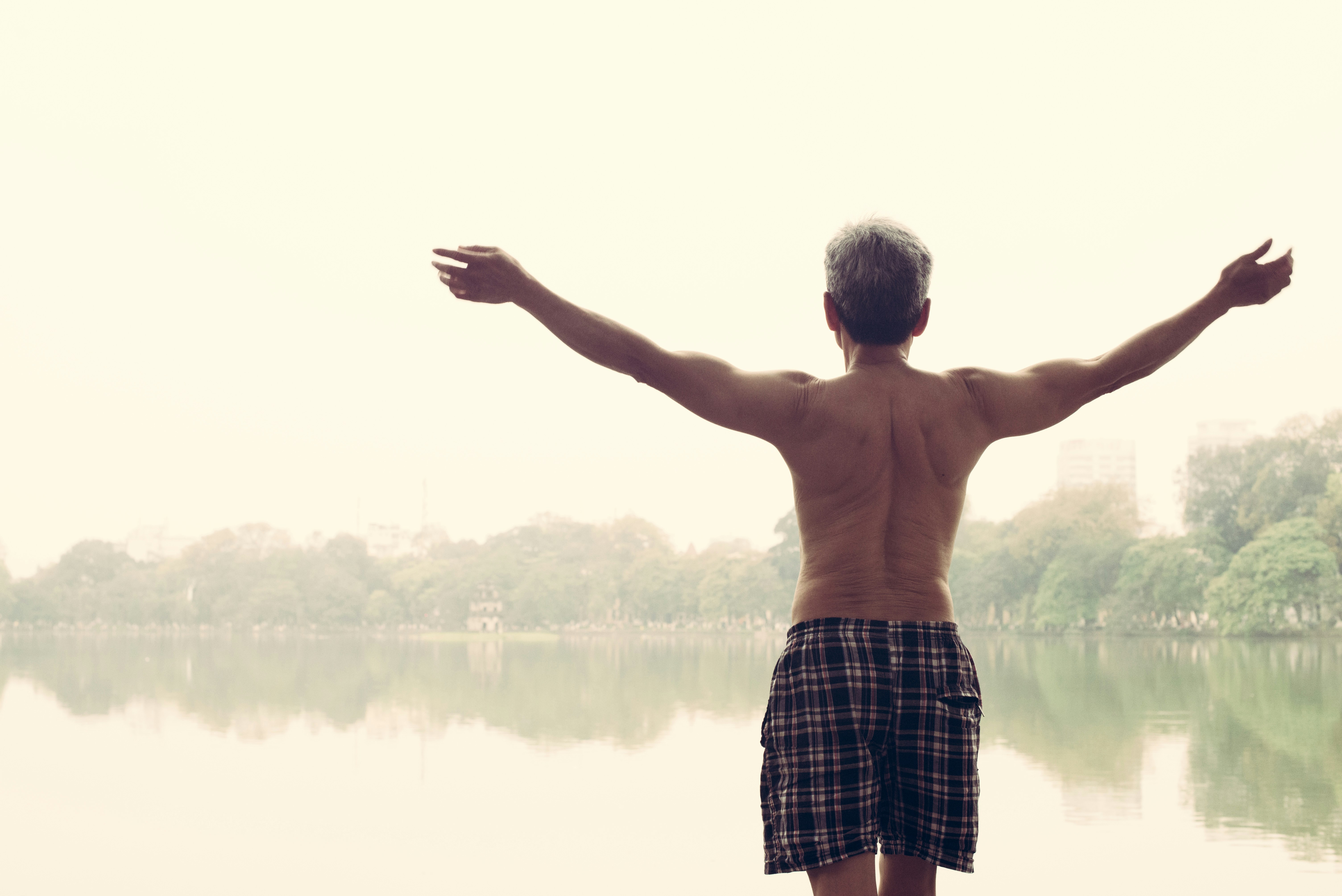 Horizon Embrace: A Lone Figure at the Misty Lake