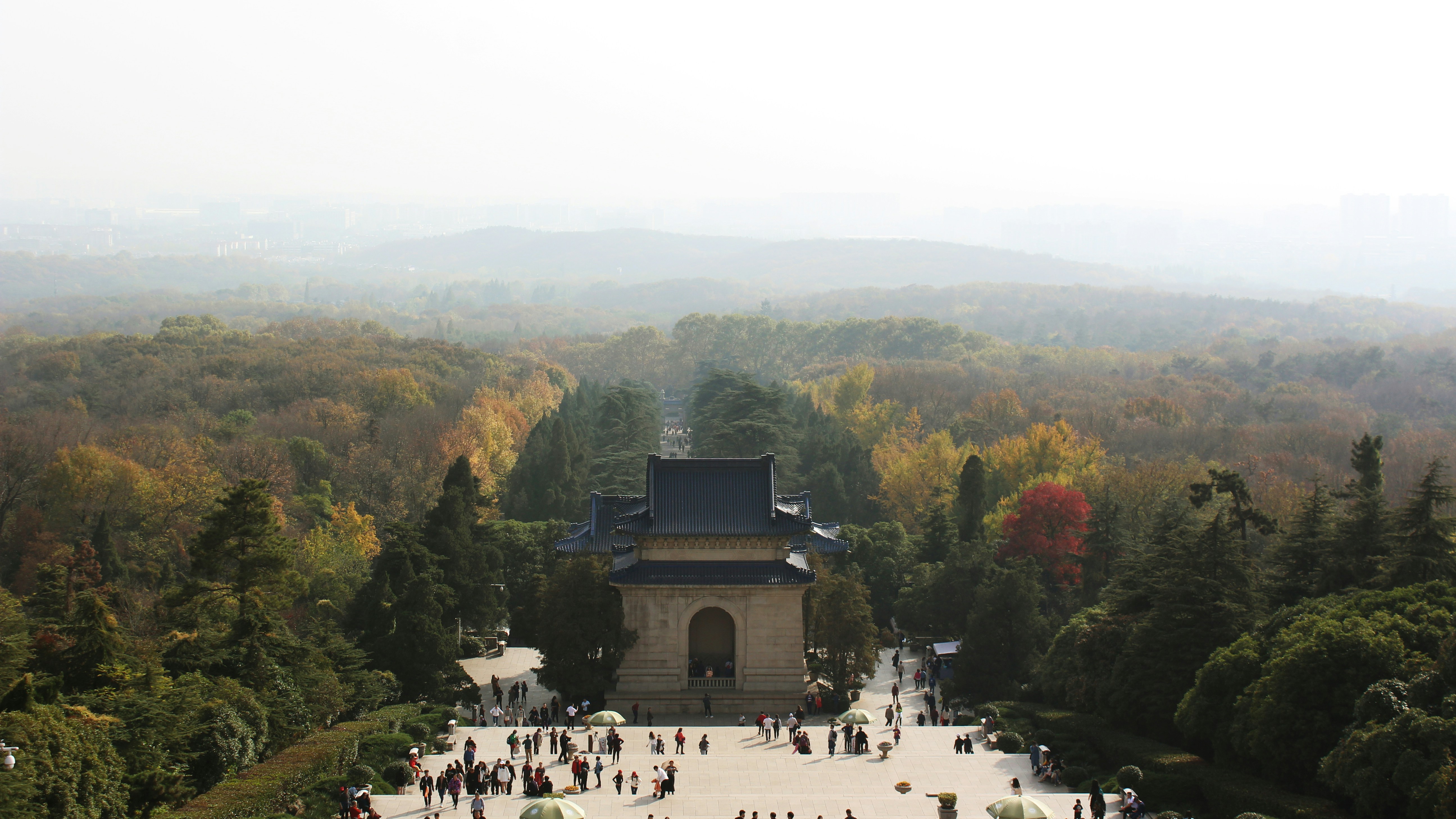 crowd near gray concrete arch during daytime
