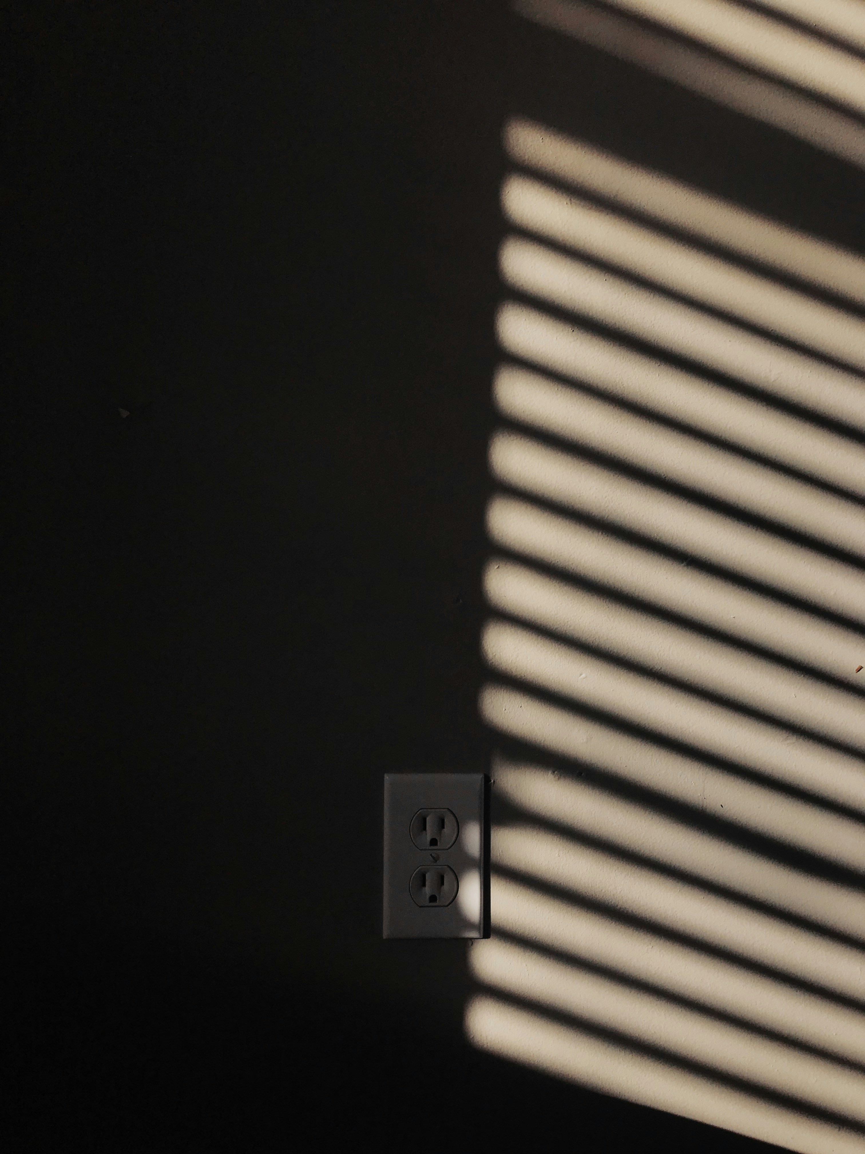 Outlet and Sunlit Stripes: Quiet Geometry on a Dark Wall