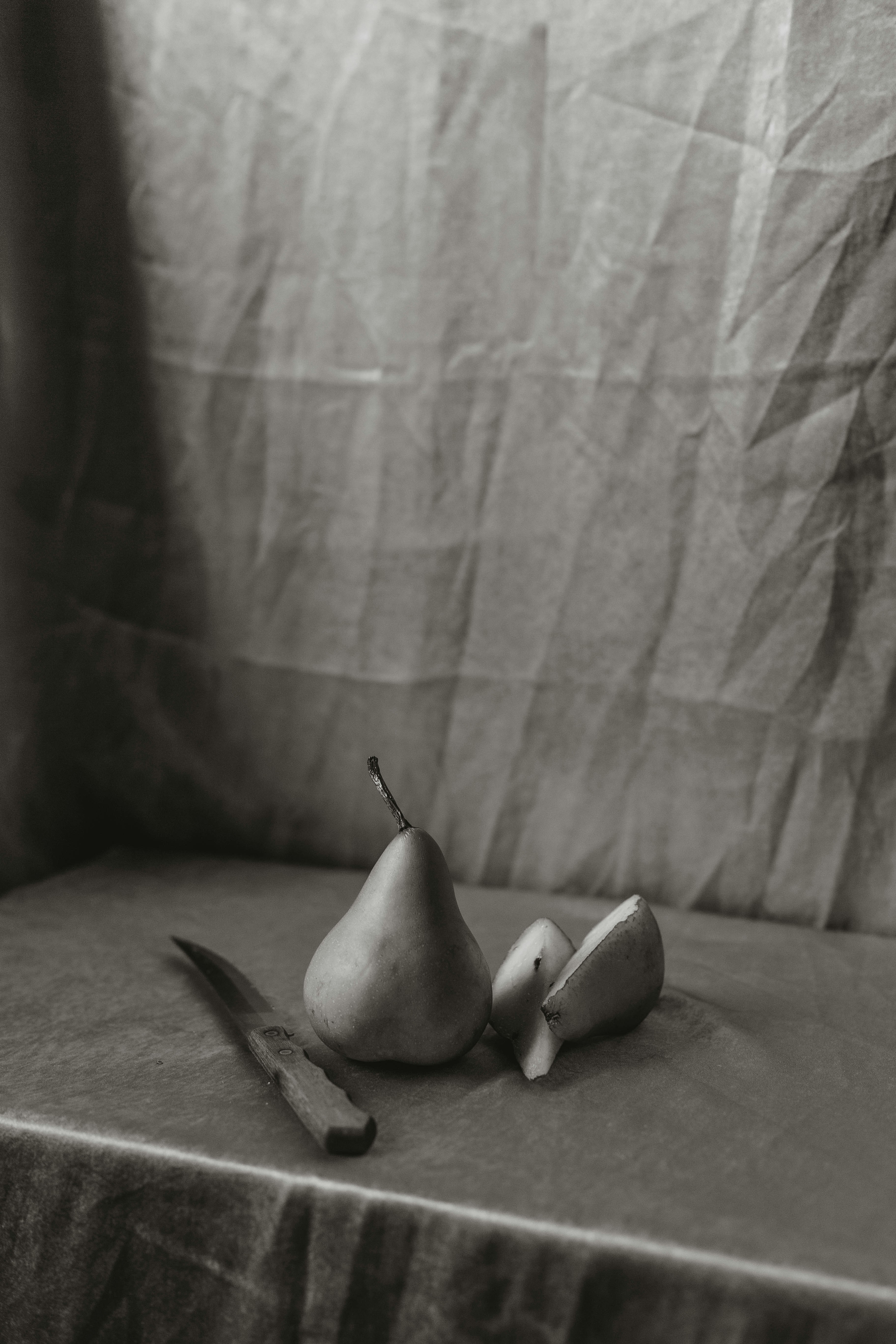 Standby Pear on a Texture-Washed Table: A Minimalist Monochrome Still Life