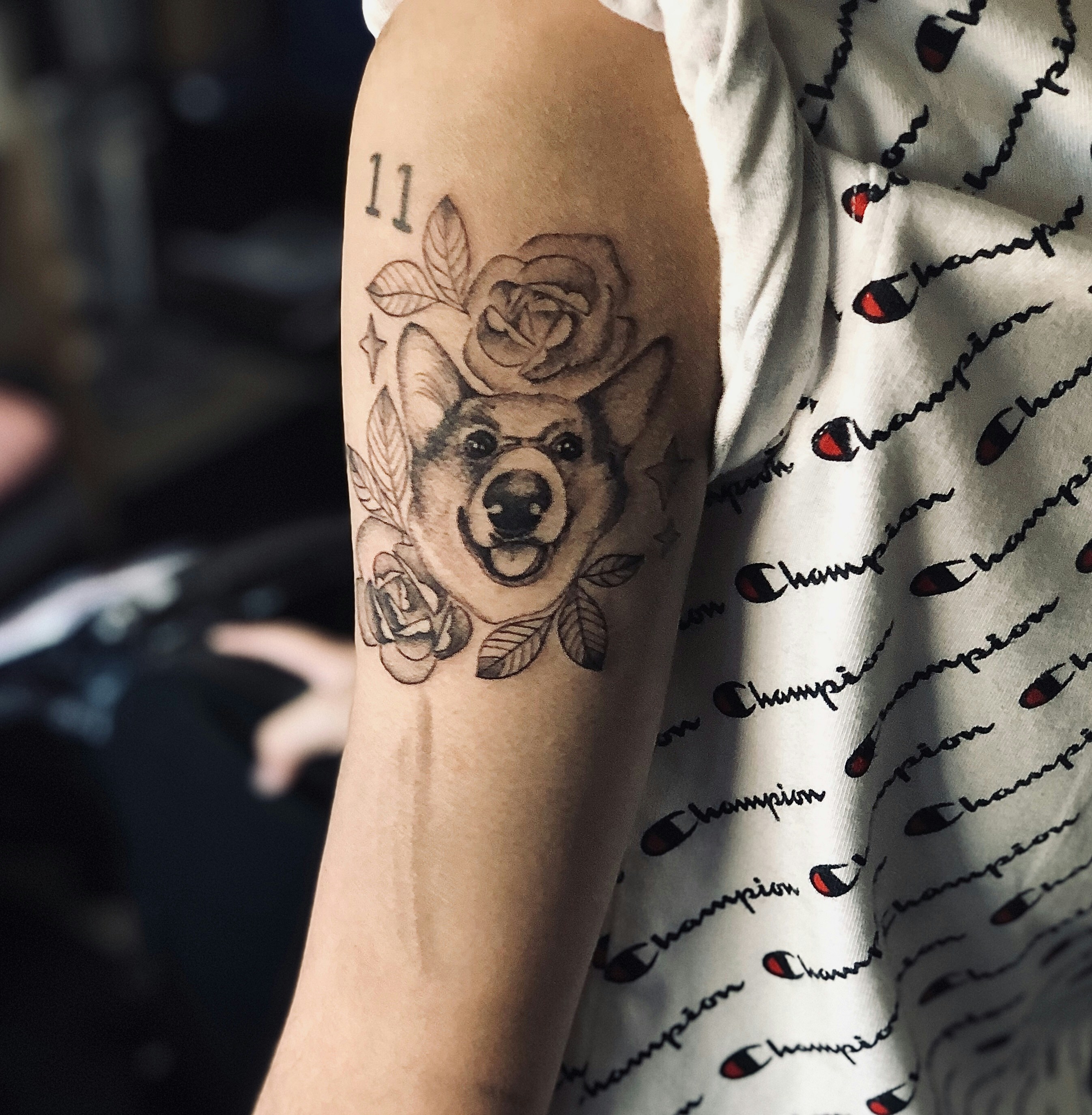 Smiling Hound Amid Roses: A Forearm Tattoo in Focus