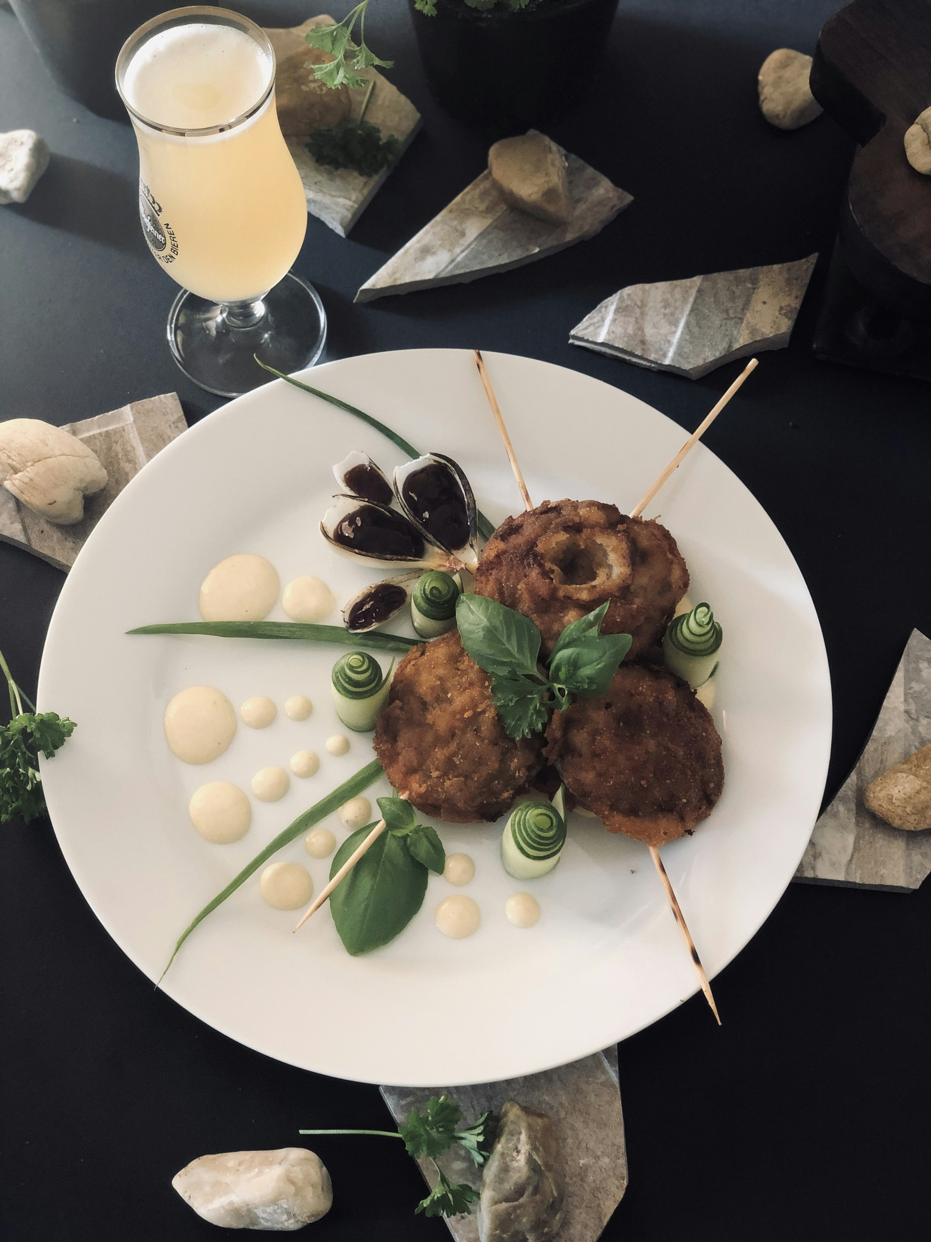 Golden Rounds and Greens: Elegant Appetizers on a Black Table