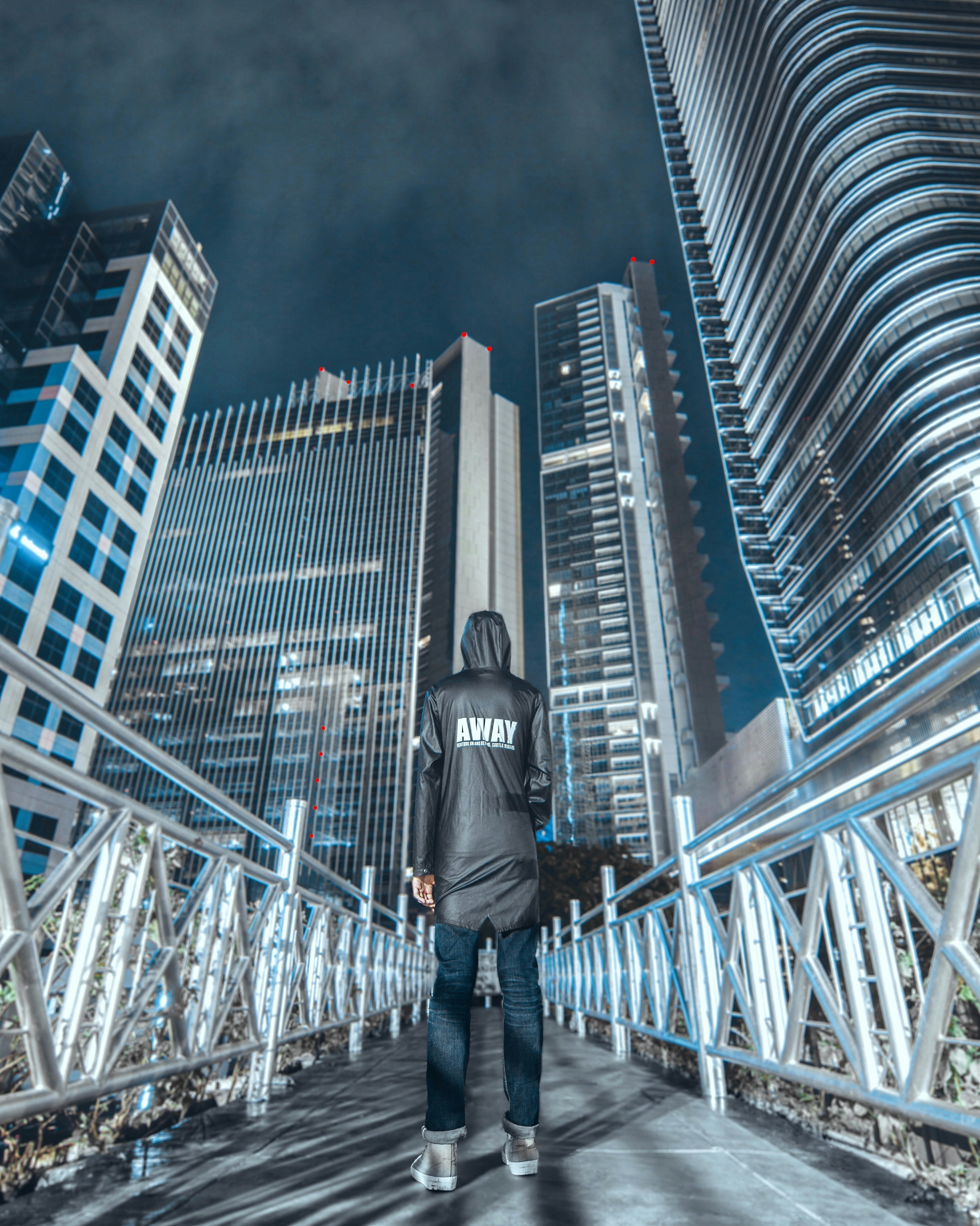 A figure in a hooded jacket stands on a bridge surrounded by towering skyscrapers, illuminated by night lights. The scene captures the essence of urban exploration.