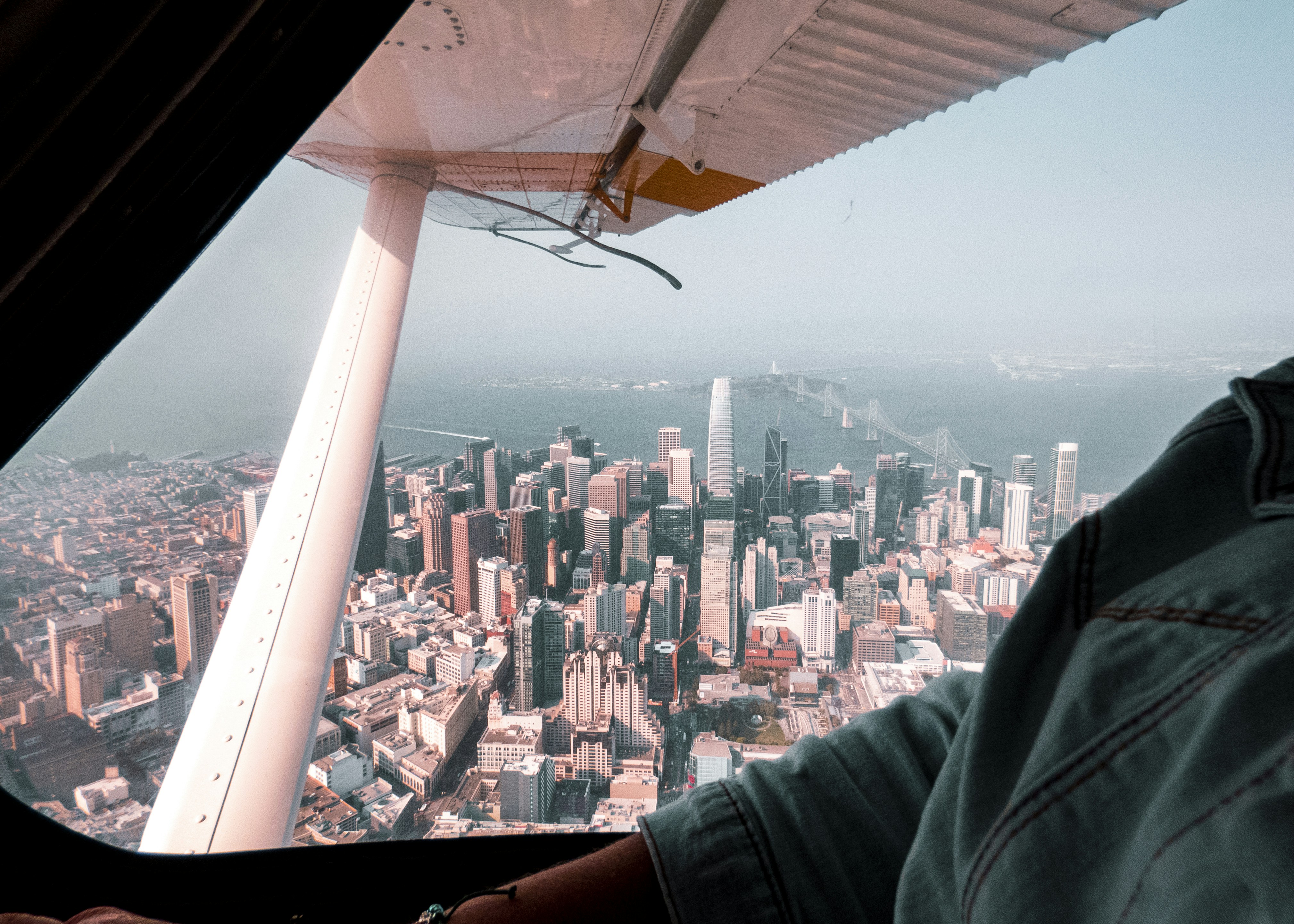 Winged Perspective: City Grid Unfolds Beneath a Small-Plane Window