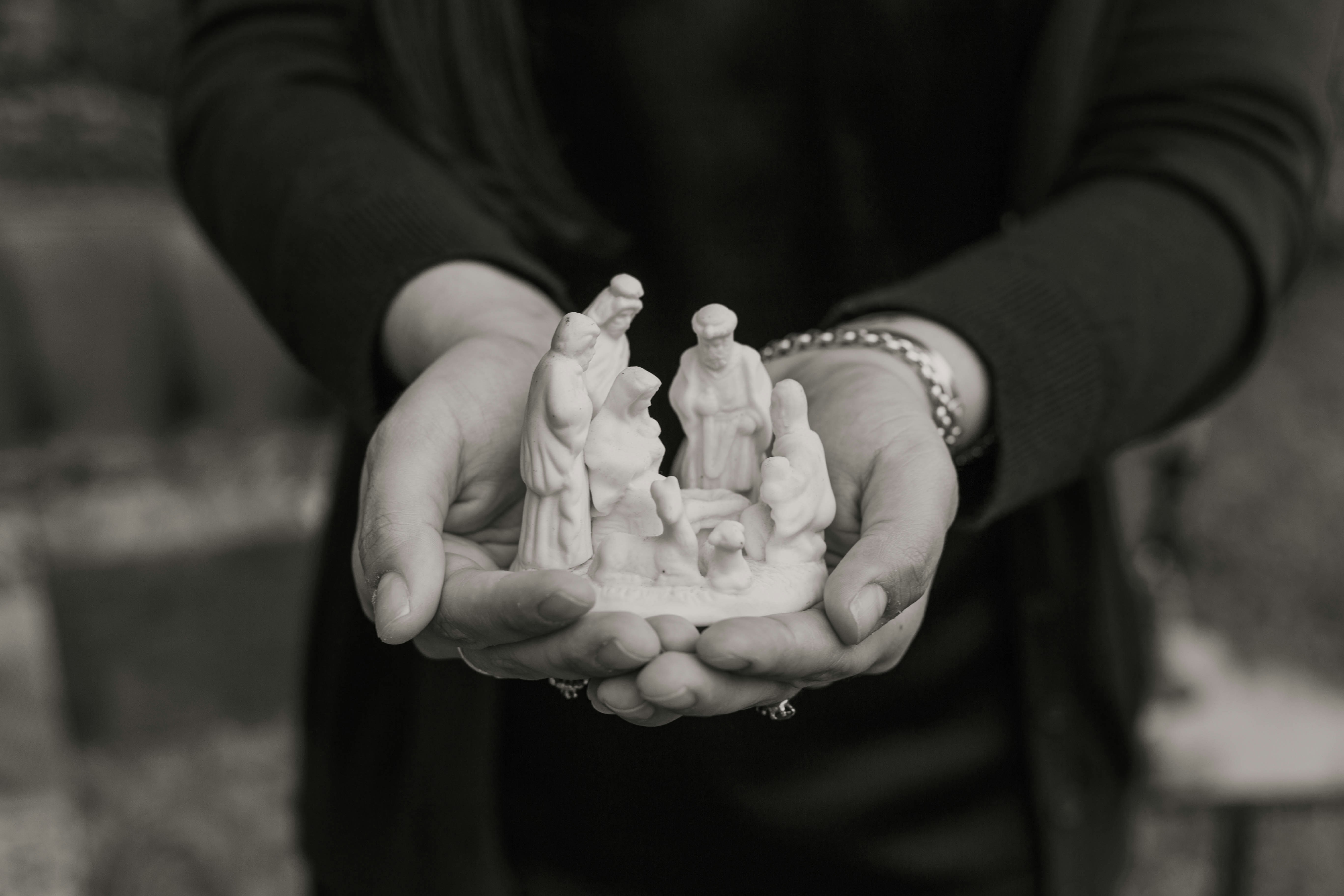Grayscale photo of person holding Nativity ceramic figurin photo – Free ...