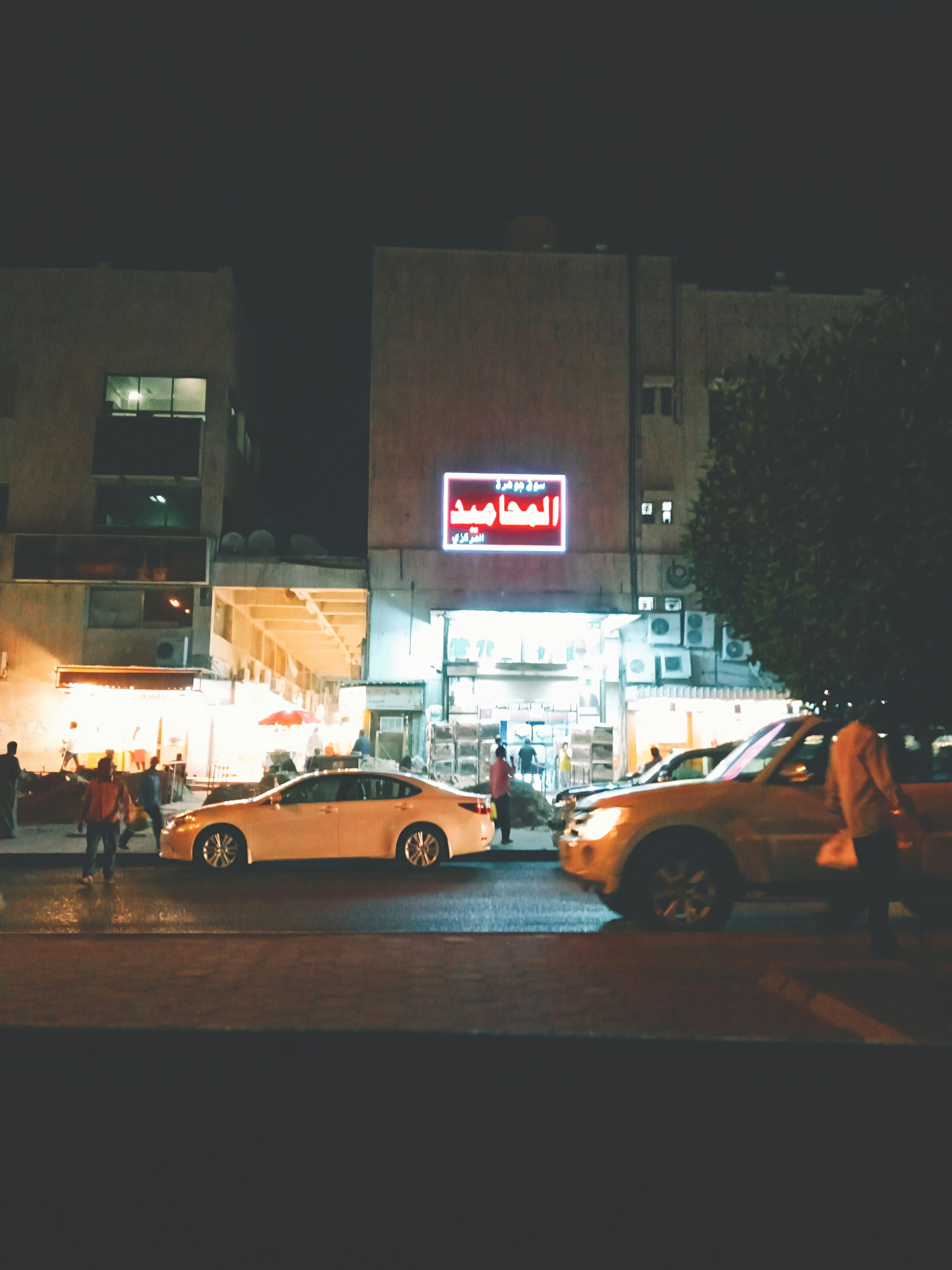 Neon Sign and Street Pulse: Night Café Row