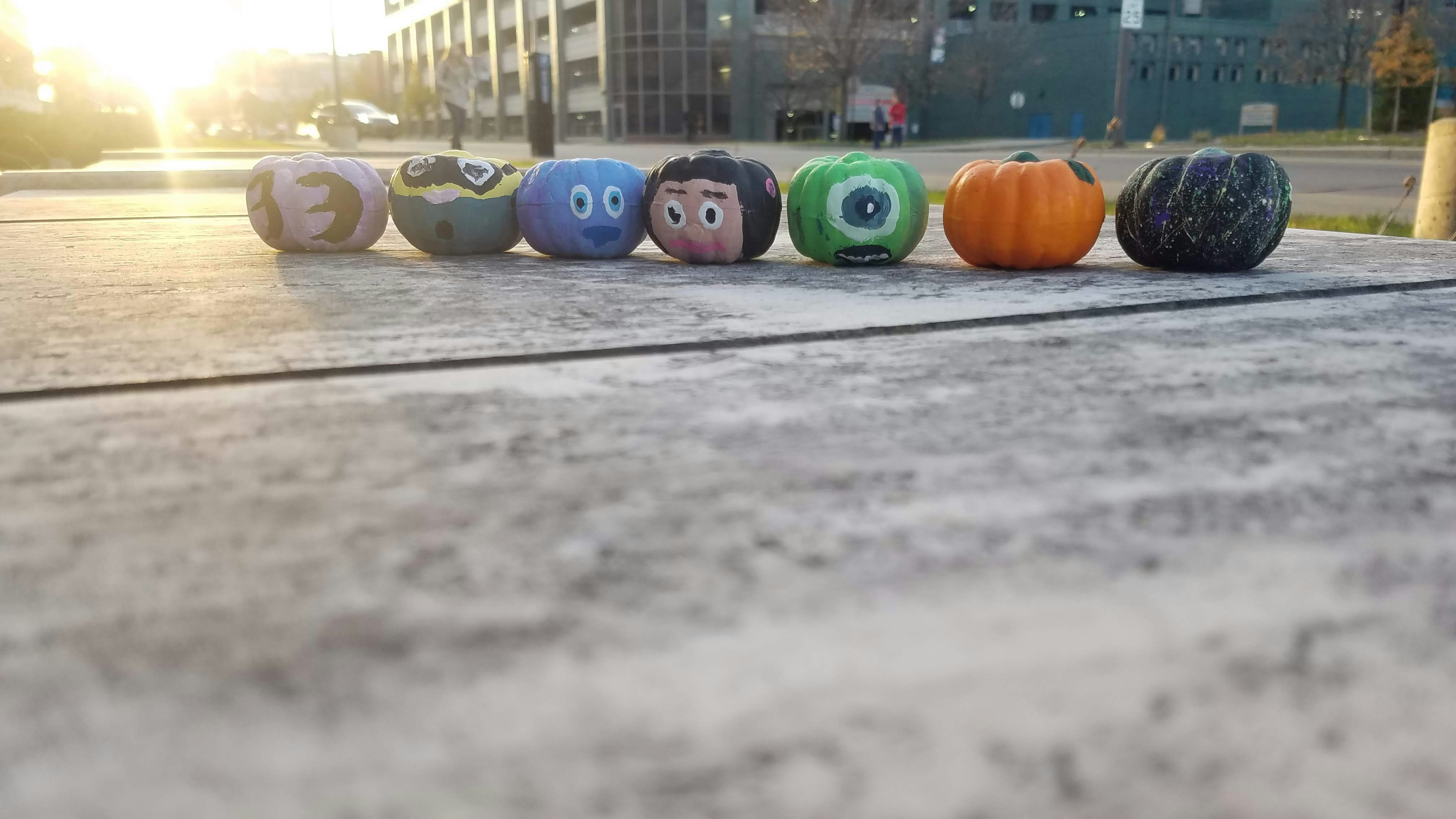 Sunrise Row of Painted Pumpkins on a Quiet City Plaza
