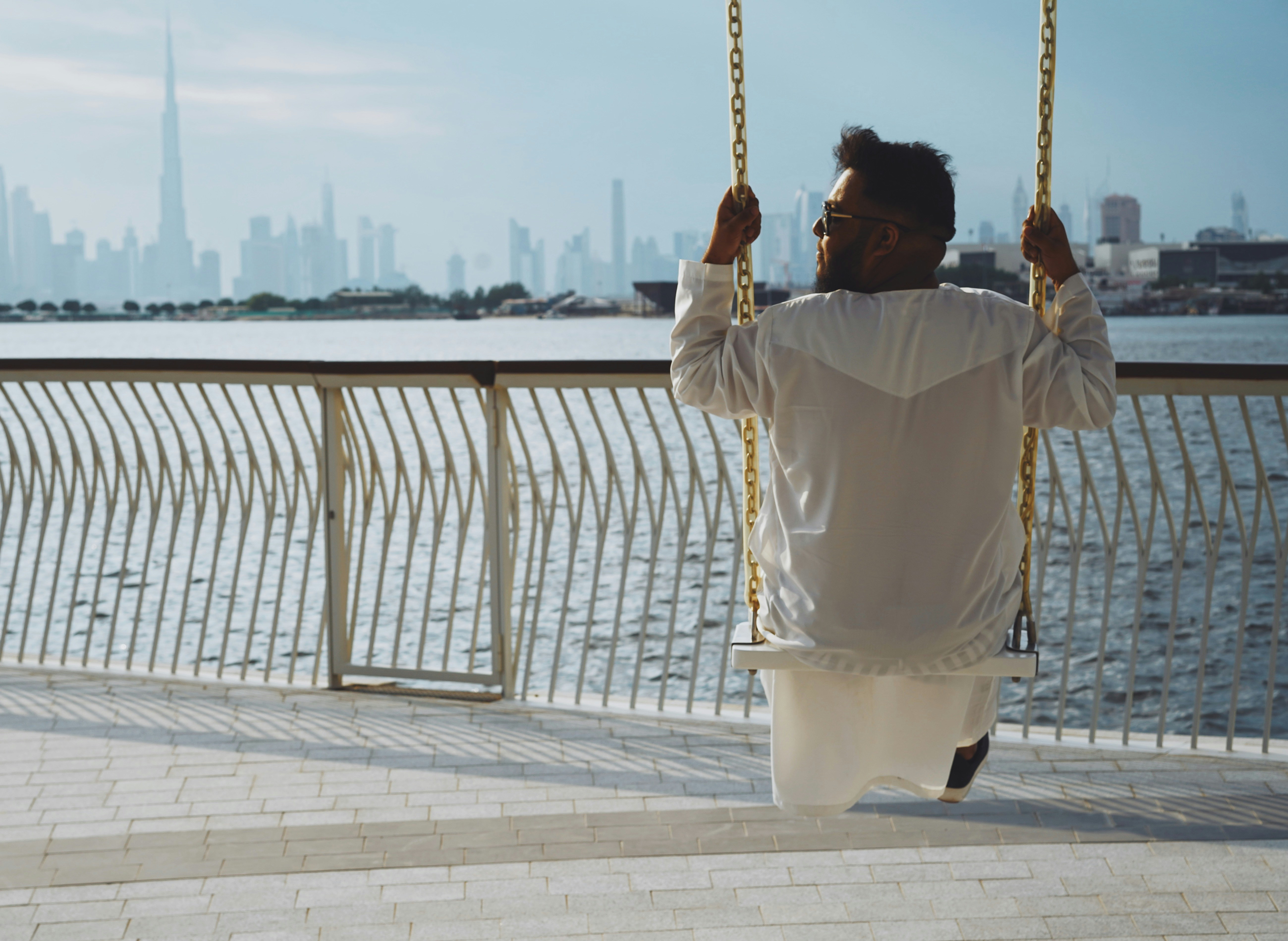 Man on swing photo – Free Dubai creek - dubai - united arab emirates ...