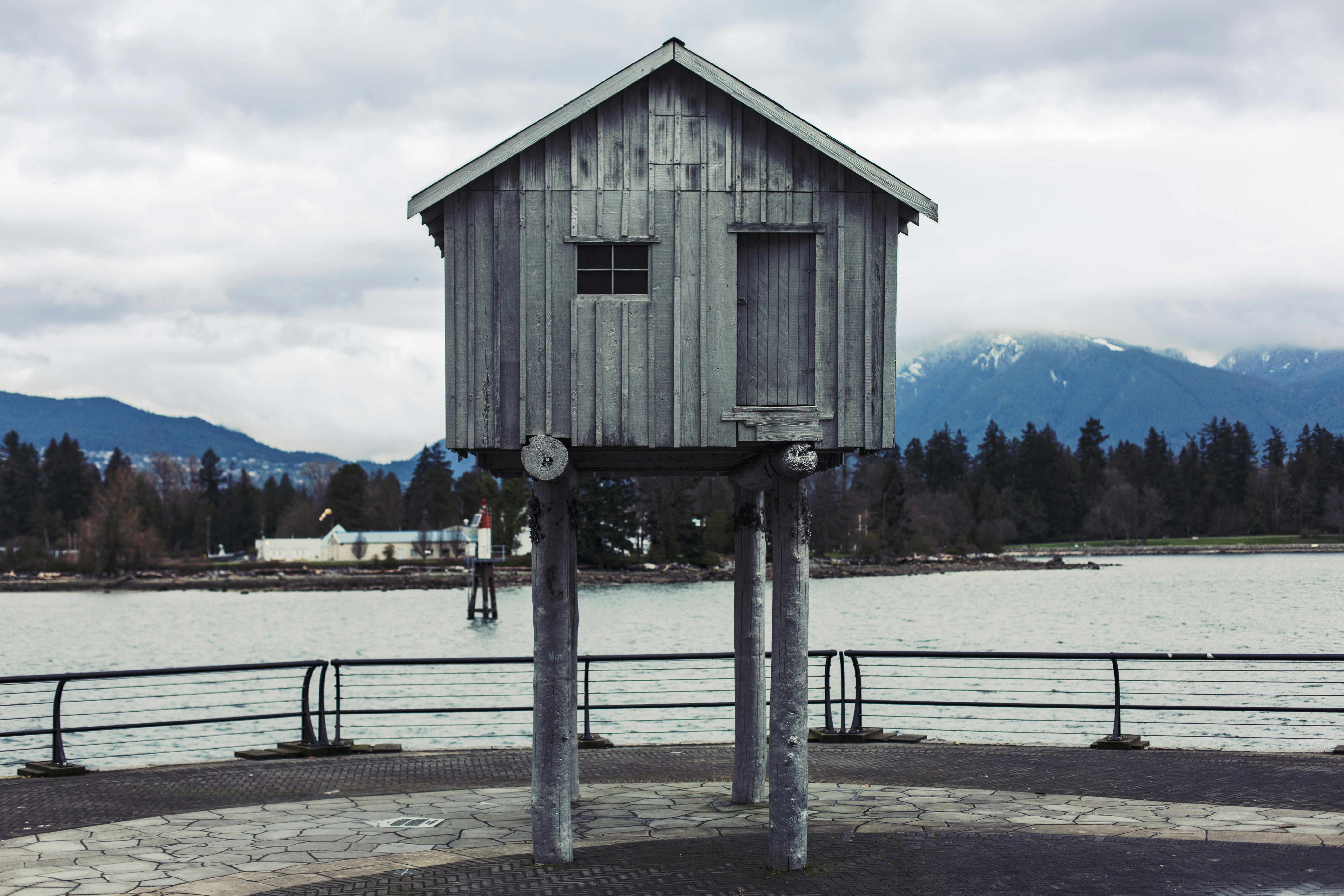 Shallow focus photo of gray shed near body of water photo – Free ...