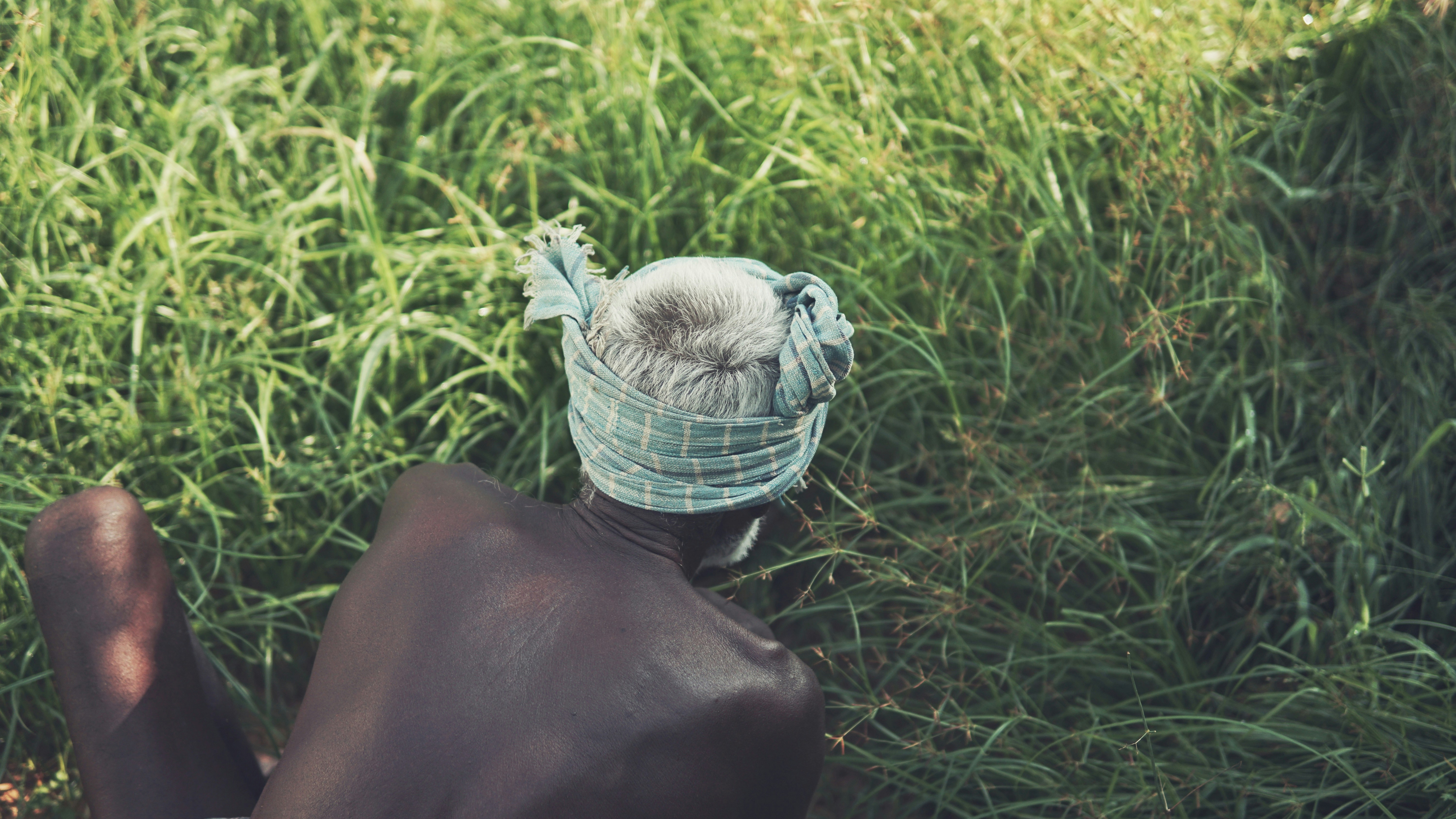 shallow focus photo of topless man wearing teal headband