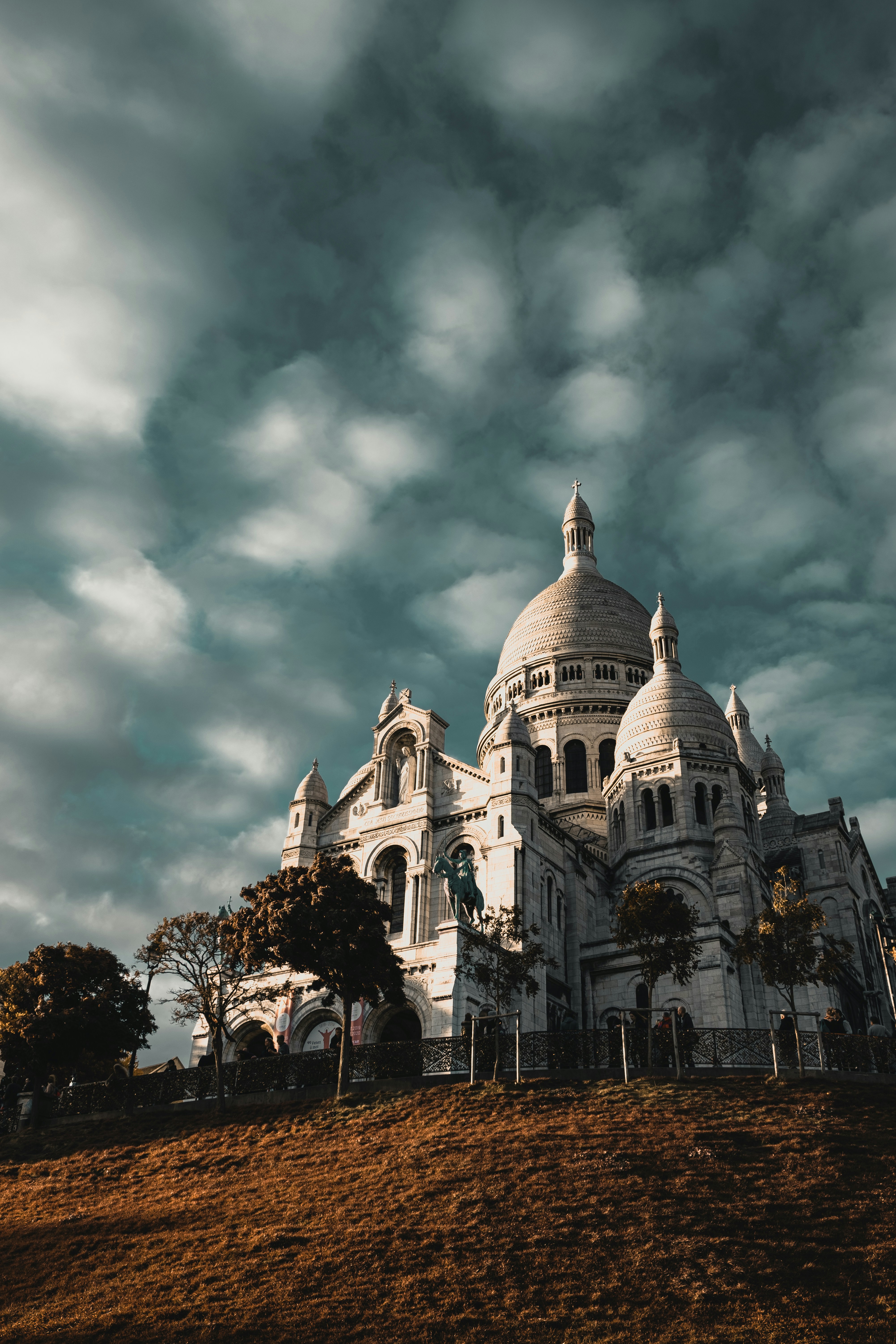 Sacre Coeur with cartoon like clouds. | white dome building under blue clouds