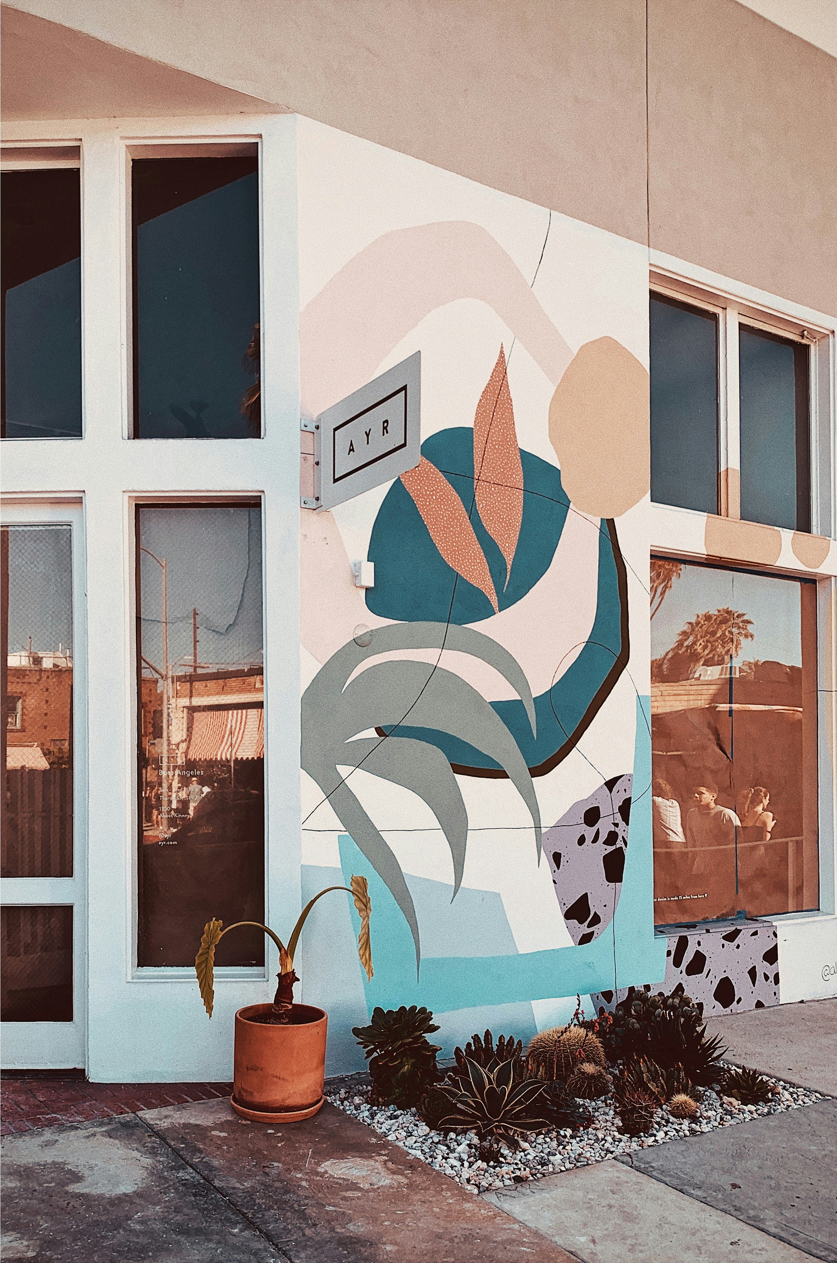Pastel Atlas: Abstract Leaf Mural Anchors a Sunlit Storefront