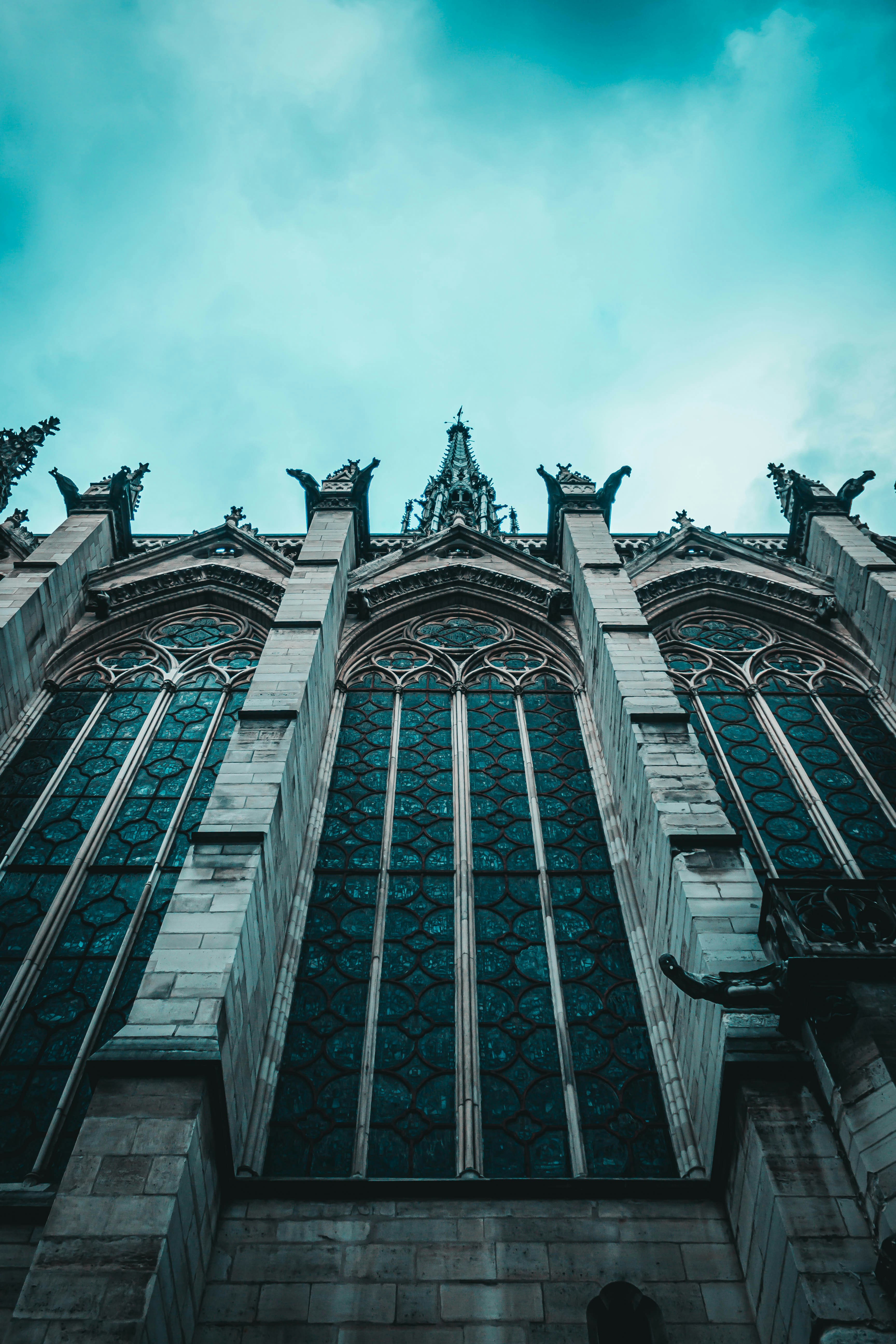Low-angle photography of blue high-rise building under blue and white ...